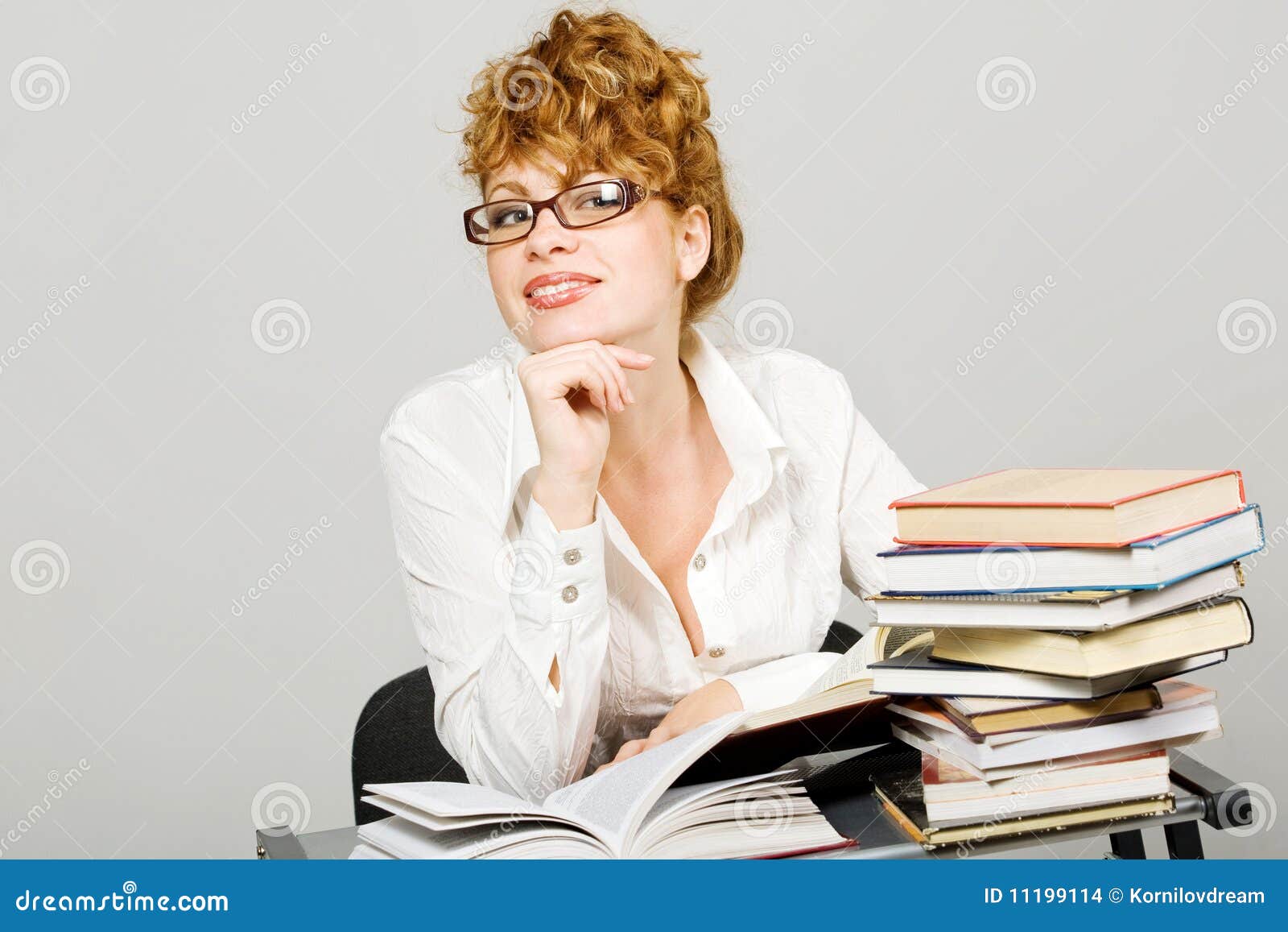 Redhead Lady Sitting at Desk with Books Stack Stock Photo - Image of ...