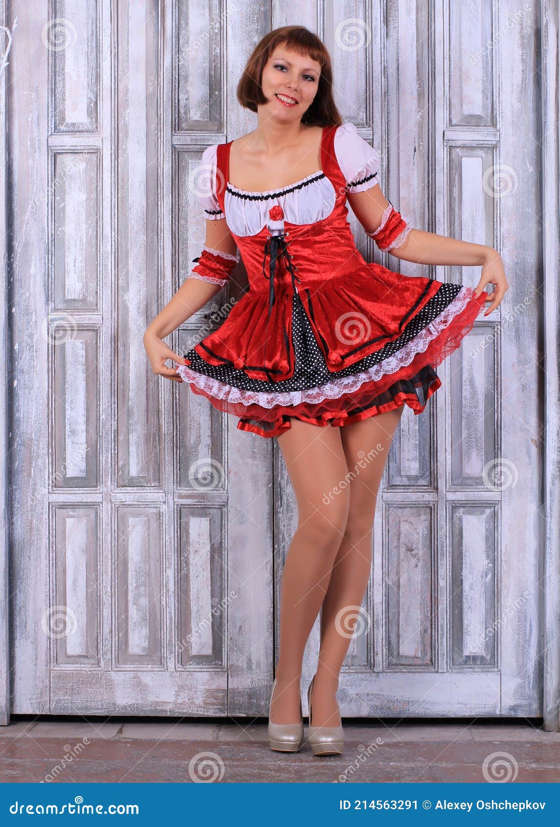 Redhead Legged Photomodel In Red Minidress And Stockings Posing In