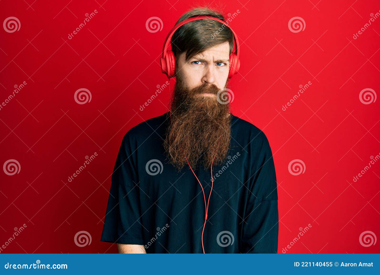 Redhead Man With Long Beard Listening To Music Using Headphones Skeptic