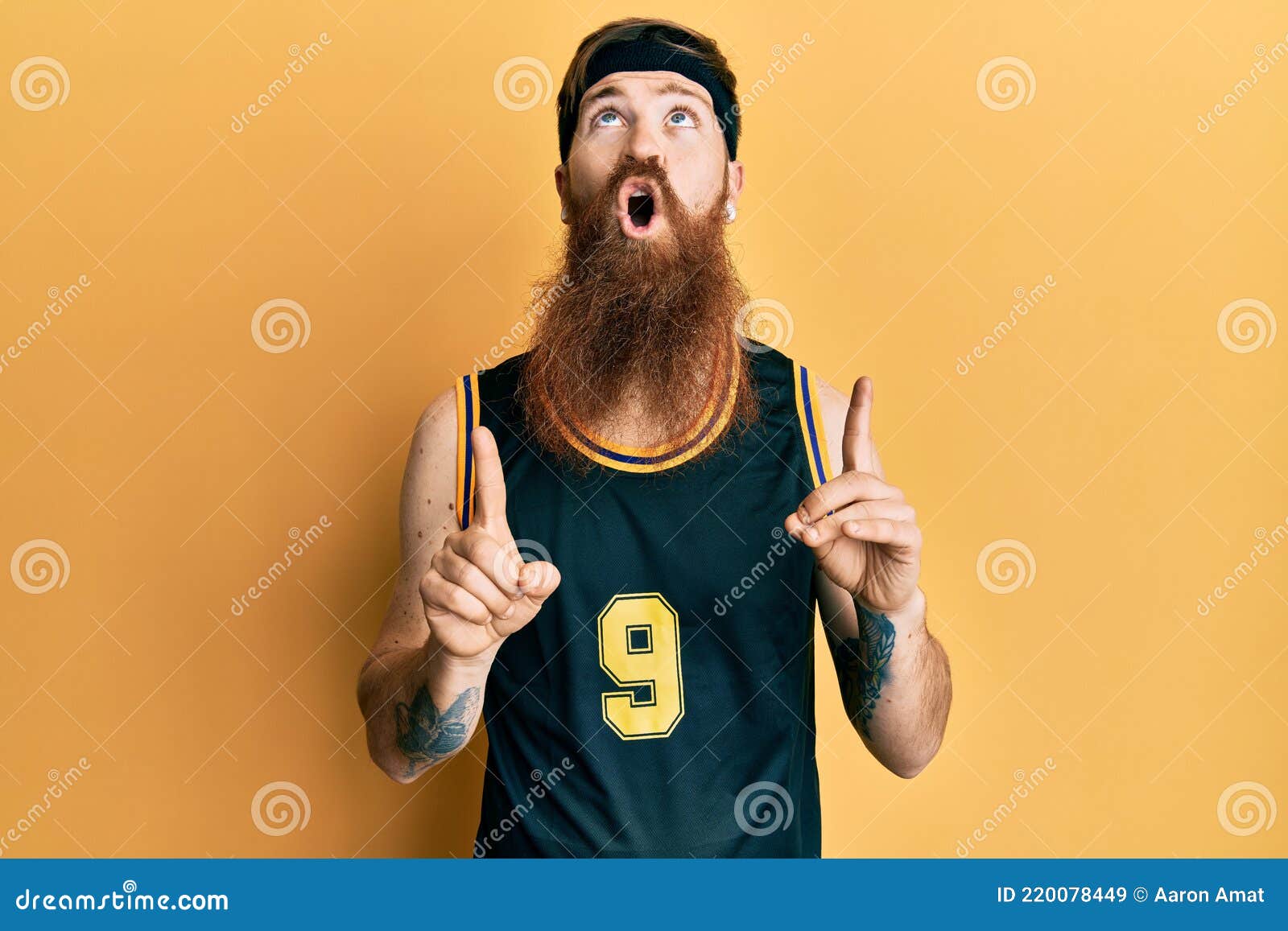 Redhead Man With Long Beard Wearing Basketball Uniform Amazed And