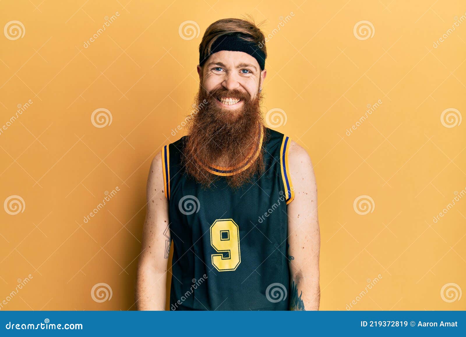 Redhead Man With Long Beard Wearing Basketball Uniform With A Happy And