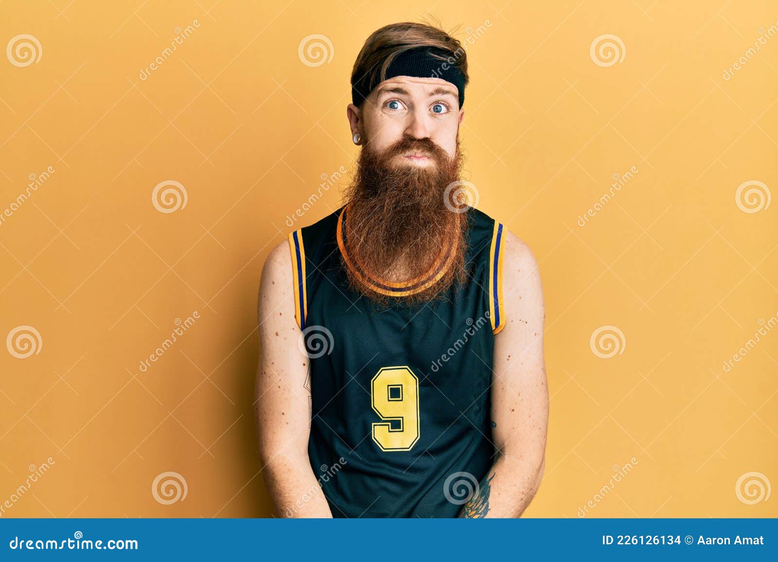Redhead Man With Long Beard Wearing Basketball Uniform Puffing Cheeks