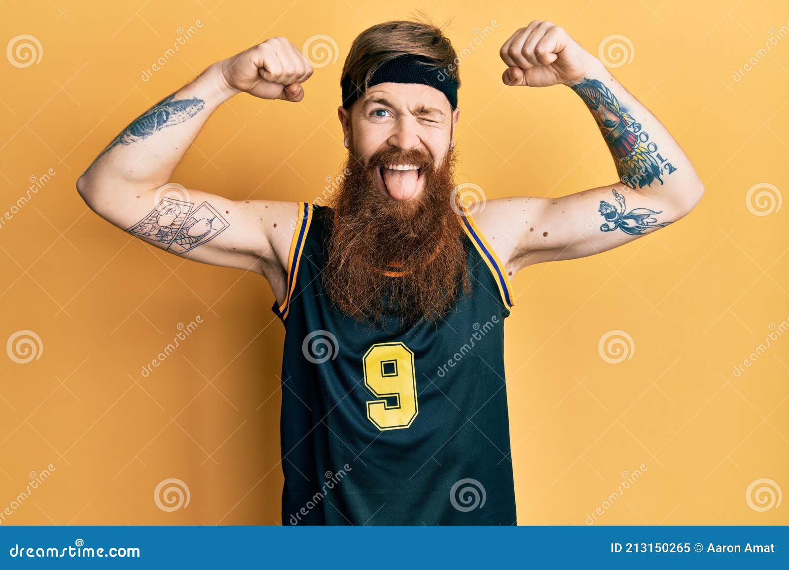 Redhead Man With Long Beard Wearing Basketball Uniform Showing Muscles