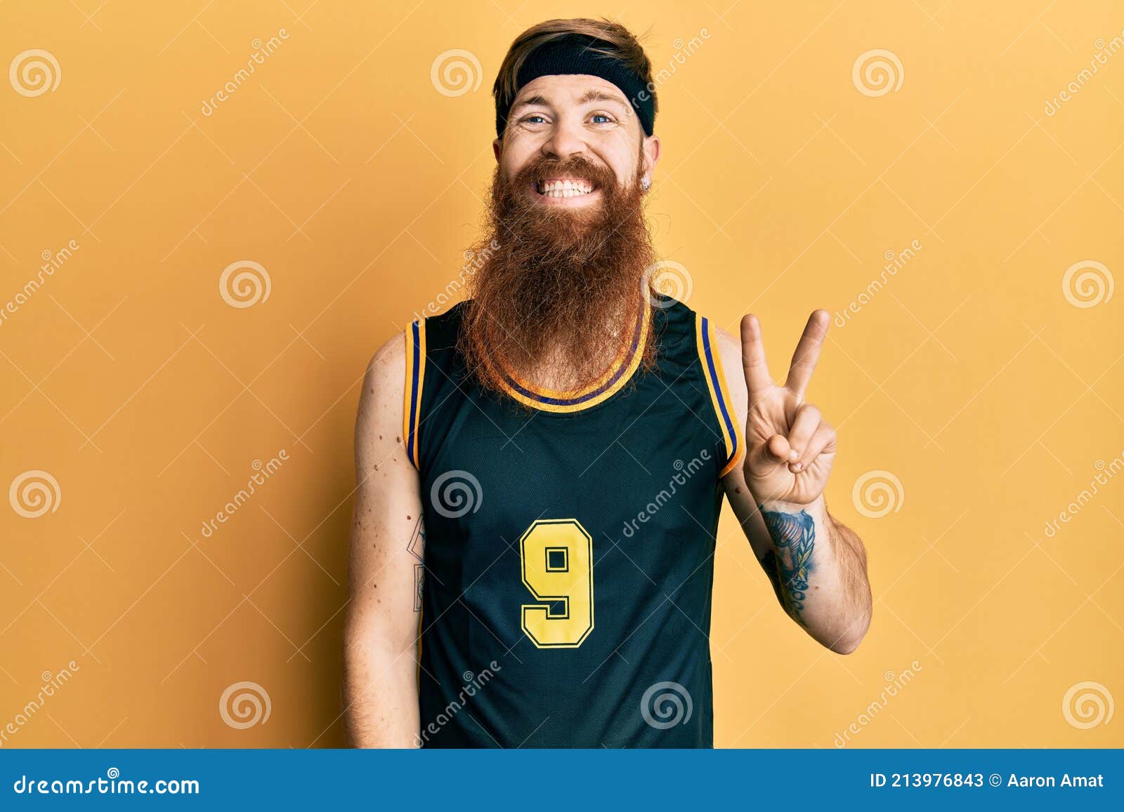 Redhead Man With Long Beard Wearing Basketball Uniform Showing And