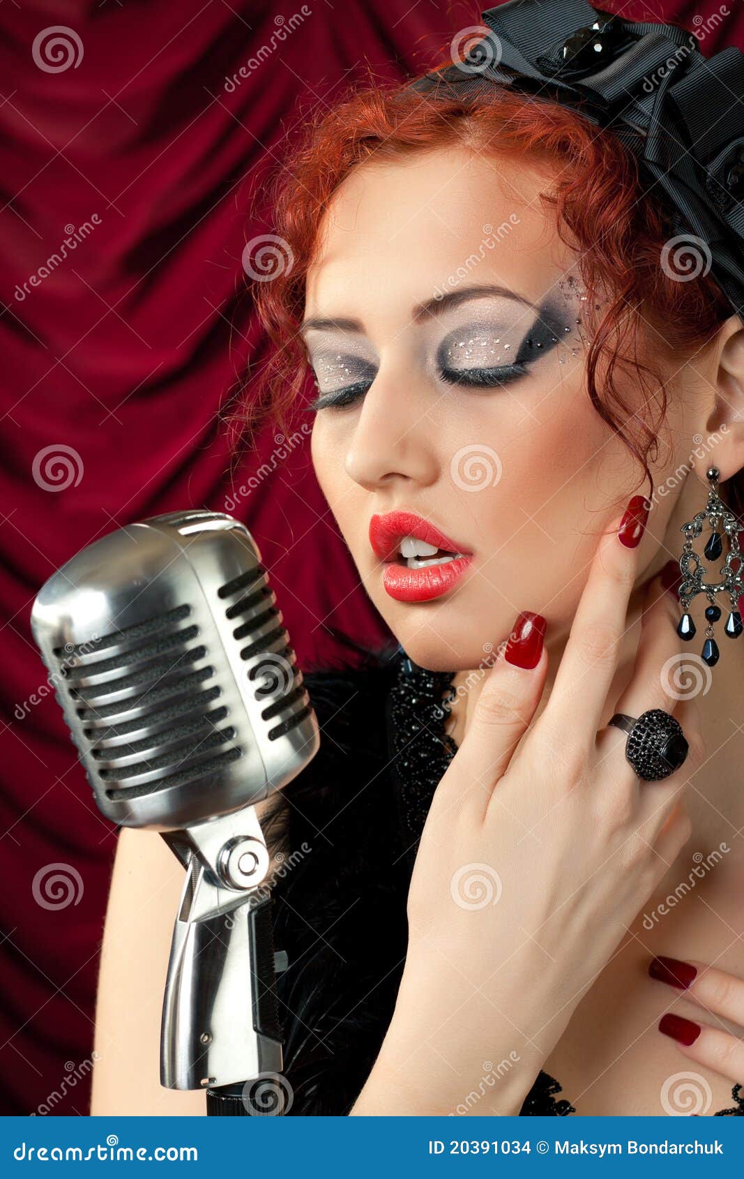Redhead Woman Singing into Vintage Microphone Stock Photo - Image of ...