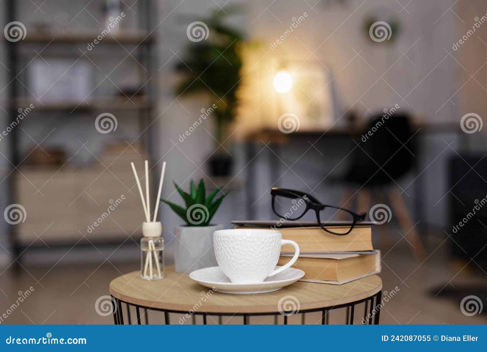 Reed Diffuser, Cup of Tea or Coffee and Books on Table in Living Room ...
