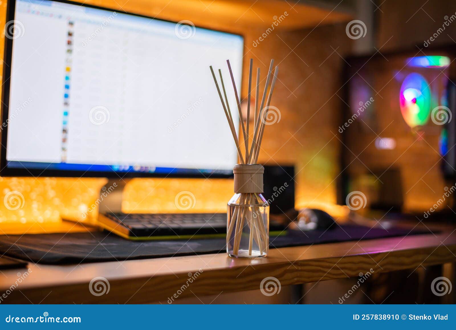 Reed Diffuser Glass Bottle is on the Wood Table with Computer To Creat ...