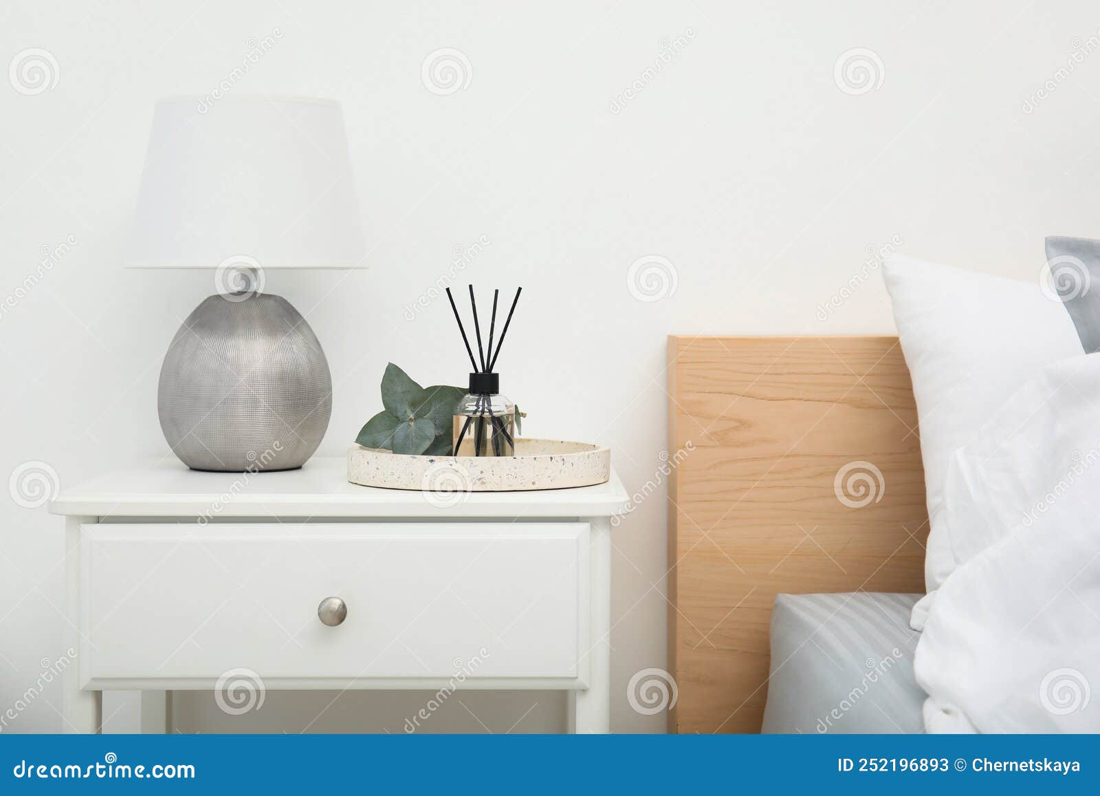 Reed Diffuser with Lamp and Eucalyptus on Nightstand in Bedroom Stock ...
