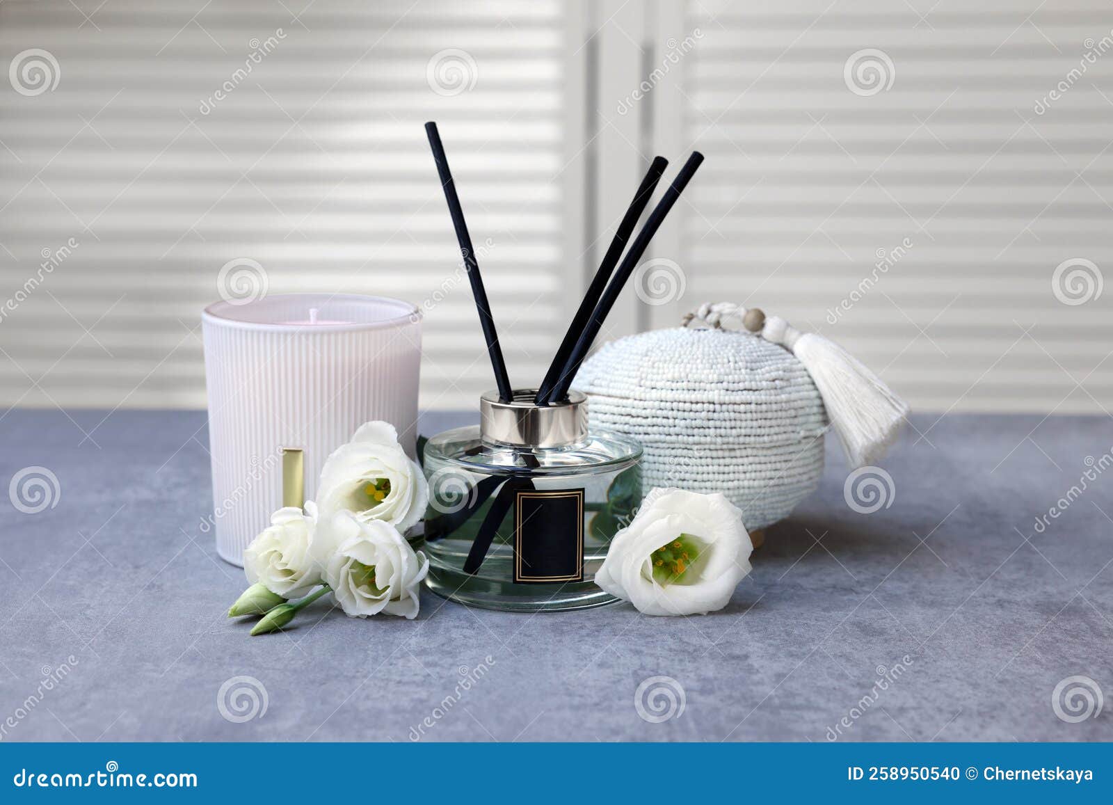 Reed Diffuser, Scented Candle, Box and Eustoma Flowers on Gray Marble ...