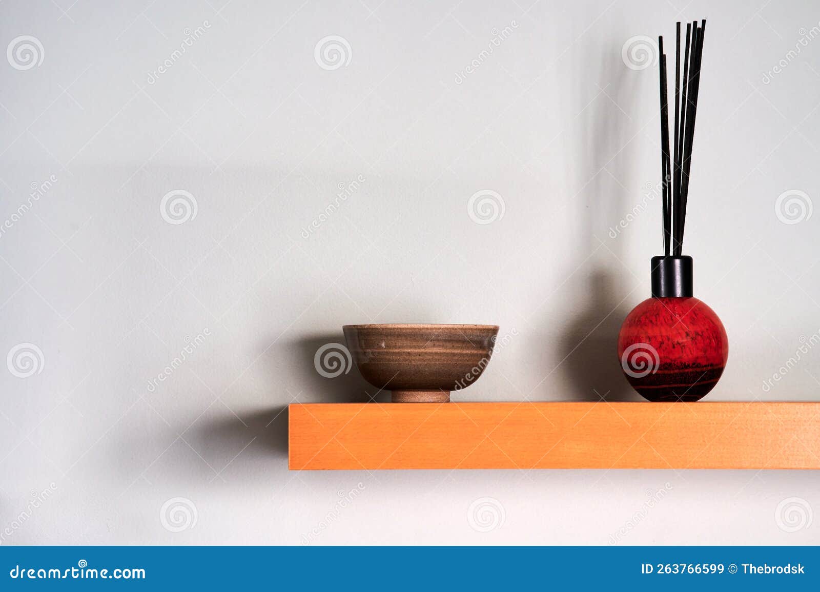 Reed Diffuser and Small Bowl on Wooden Shelf with Shadows on Wall Stock ...