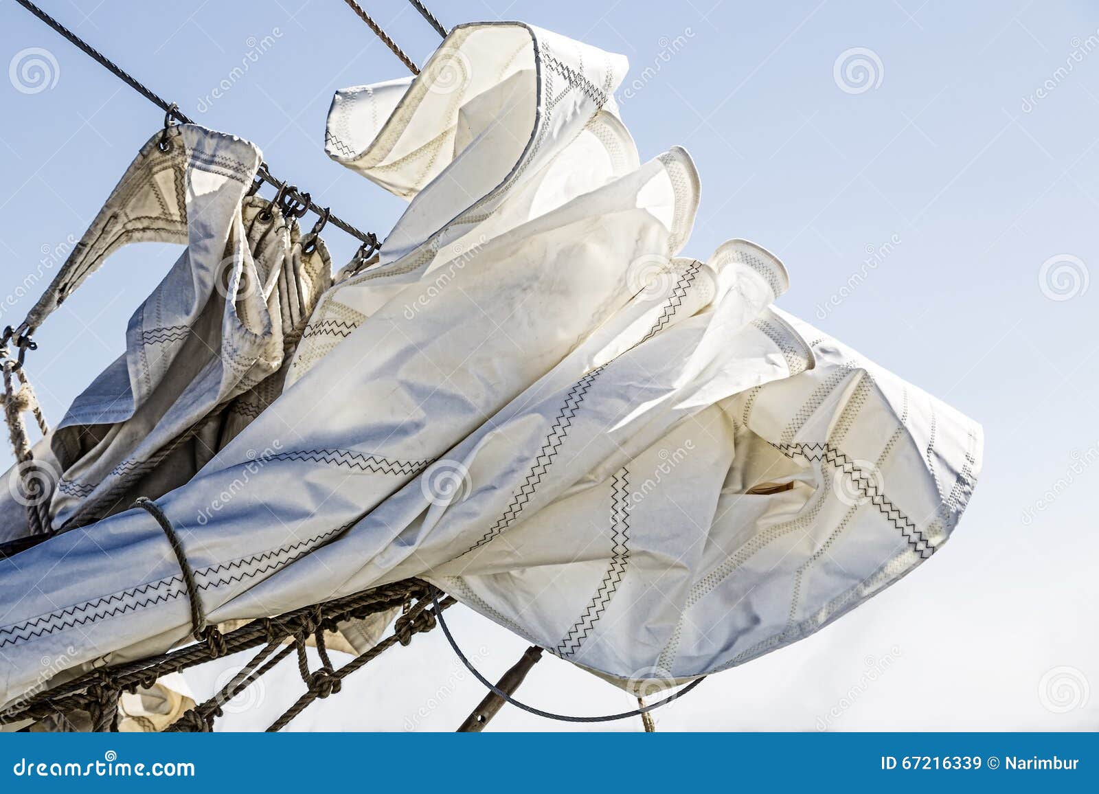Reefed sails and blue sky stock image. Image of white - 67216339