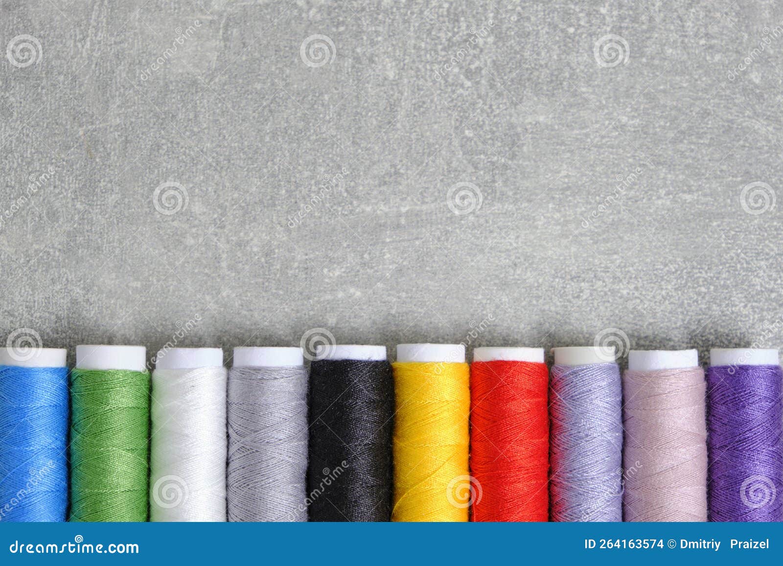 Reels with Multi Colored Sewing Threads Gray Concrete Background. Stock ...
