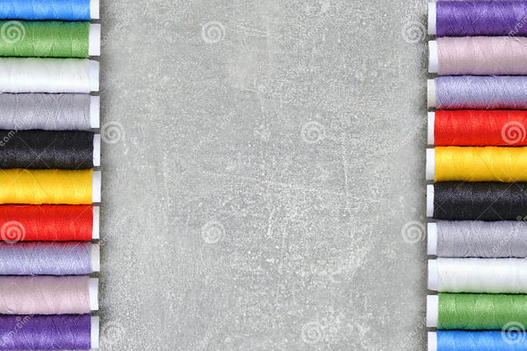 Reels with Multi Colored Sewing Threads Gray Concrete Background. Stock ...