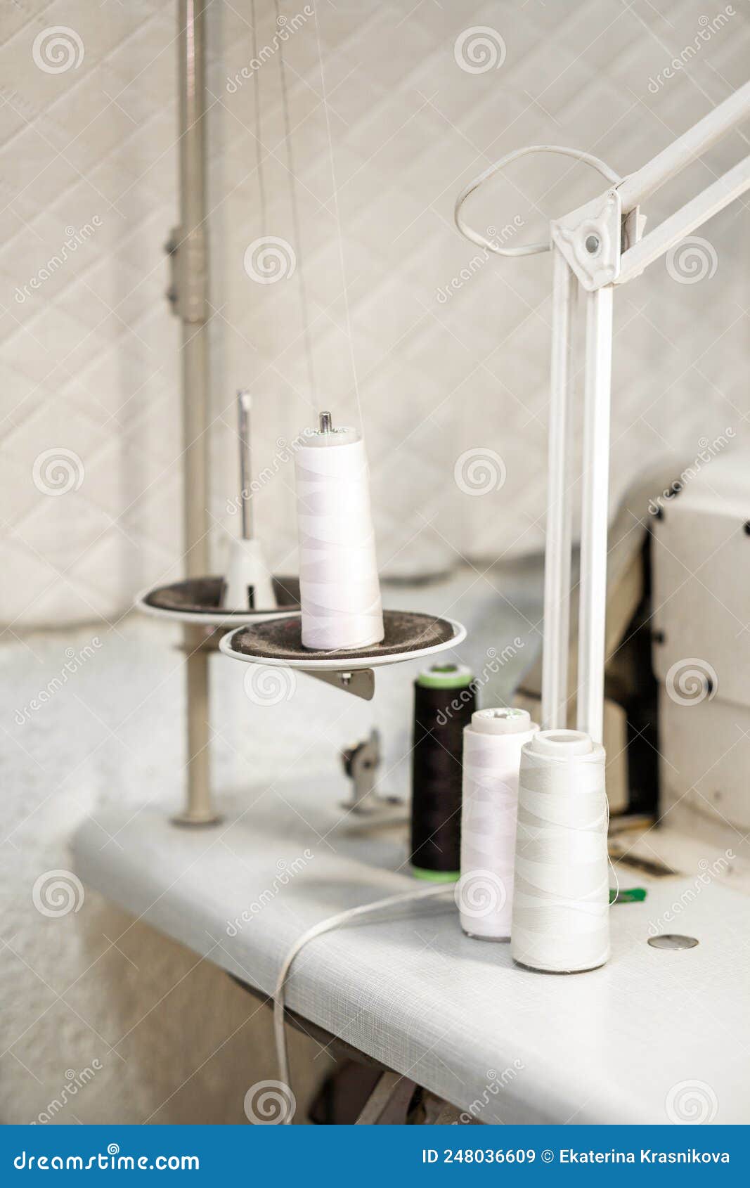 Reels with White Threads for a Sewing Machine on a Stand in Atelier ...