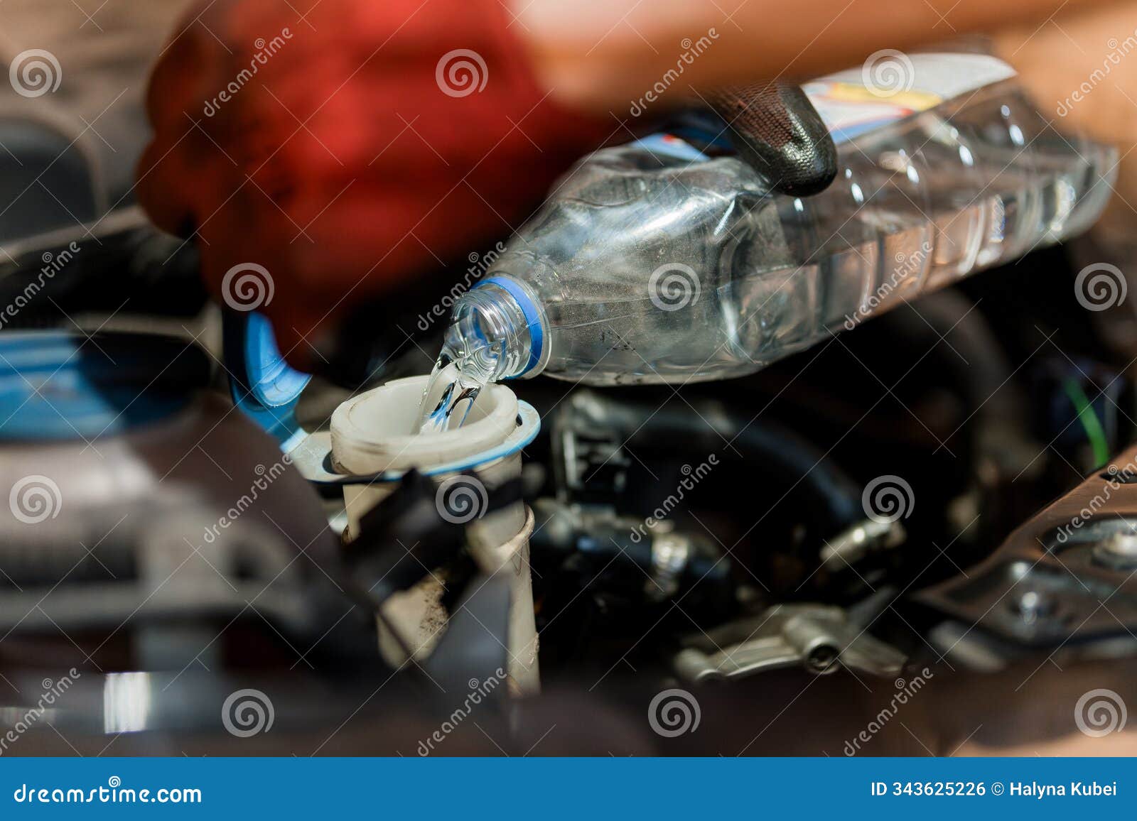Refilling Engine Coolant in a Car with a Water Bottle Stock Photo ...