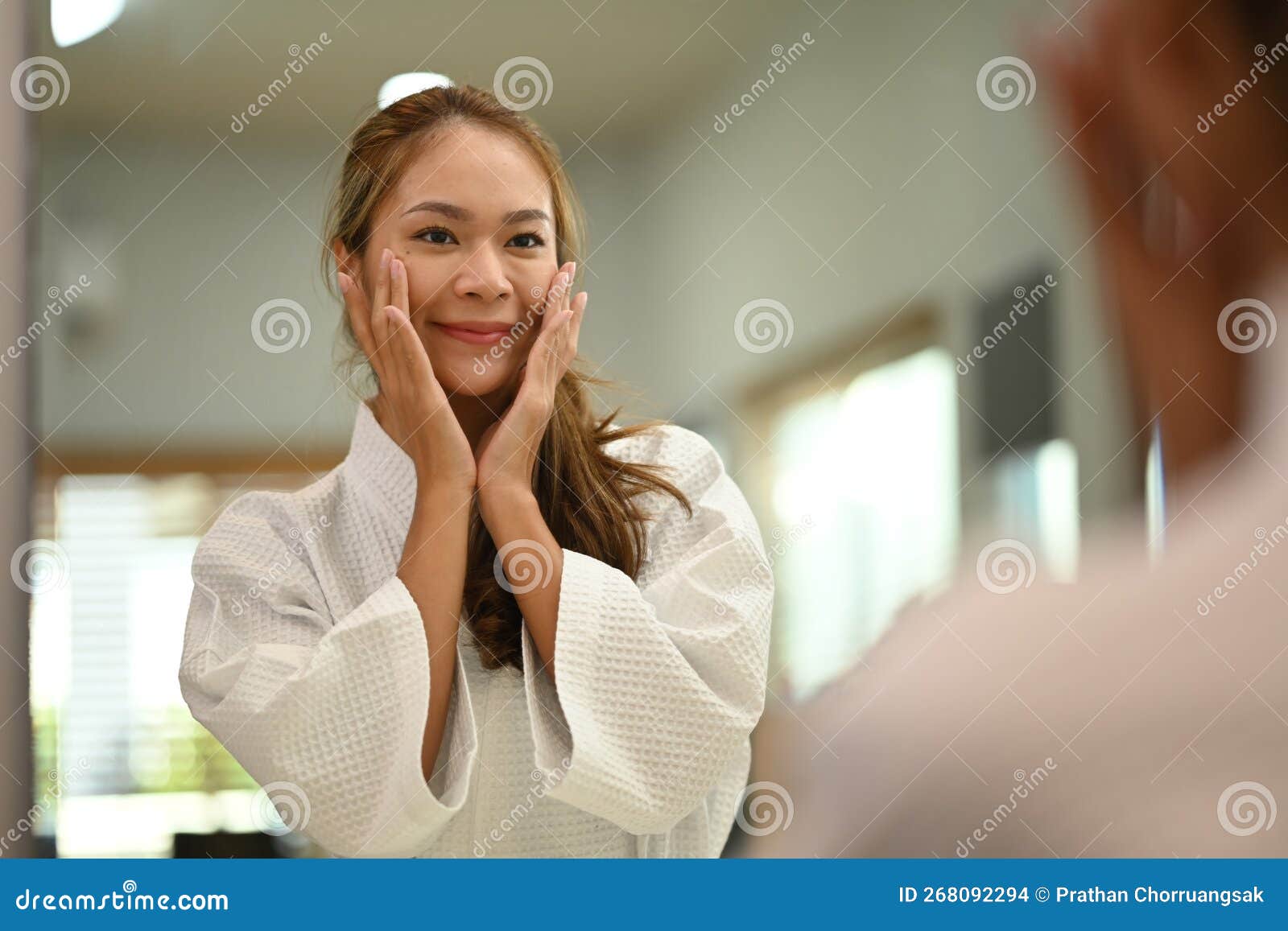 Reflecting in Mirror of Beautiful Millennial Woman in Bathrobe Standing ...