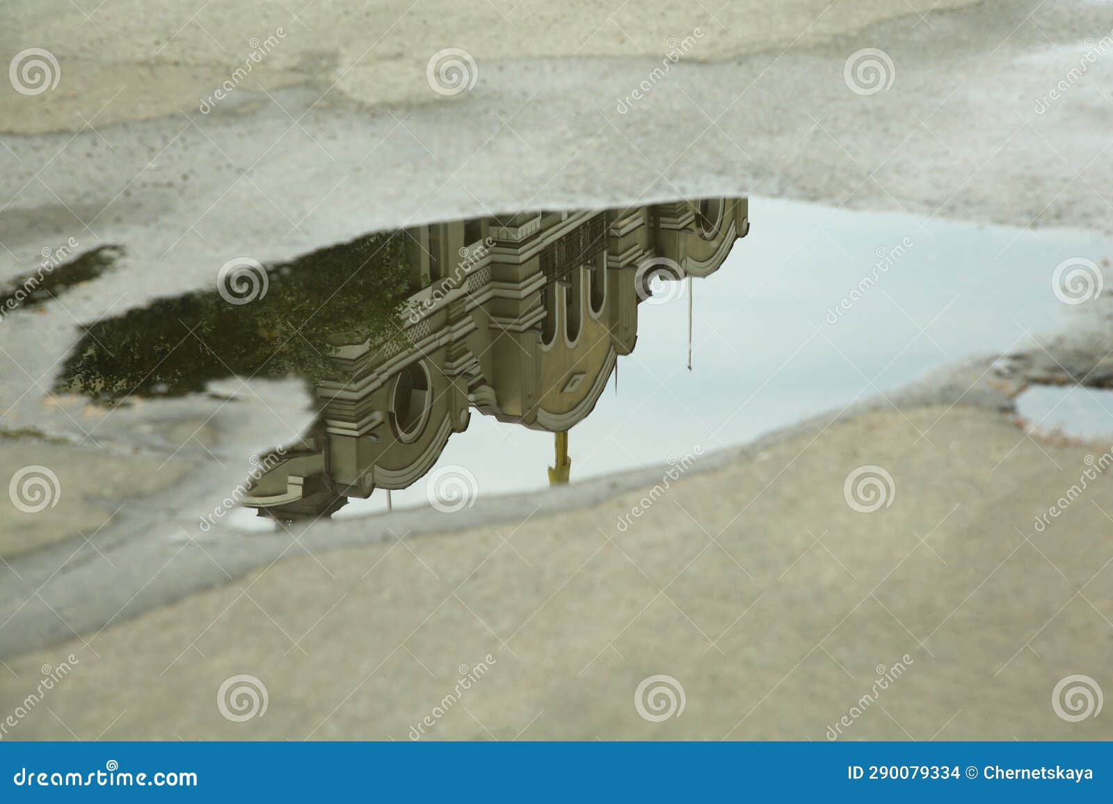 Reflection of Beautiful Building in Puddle on Asphalt Stock Photo ...