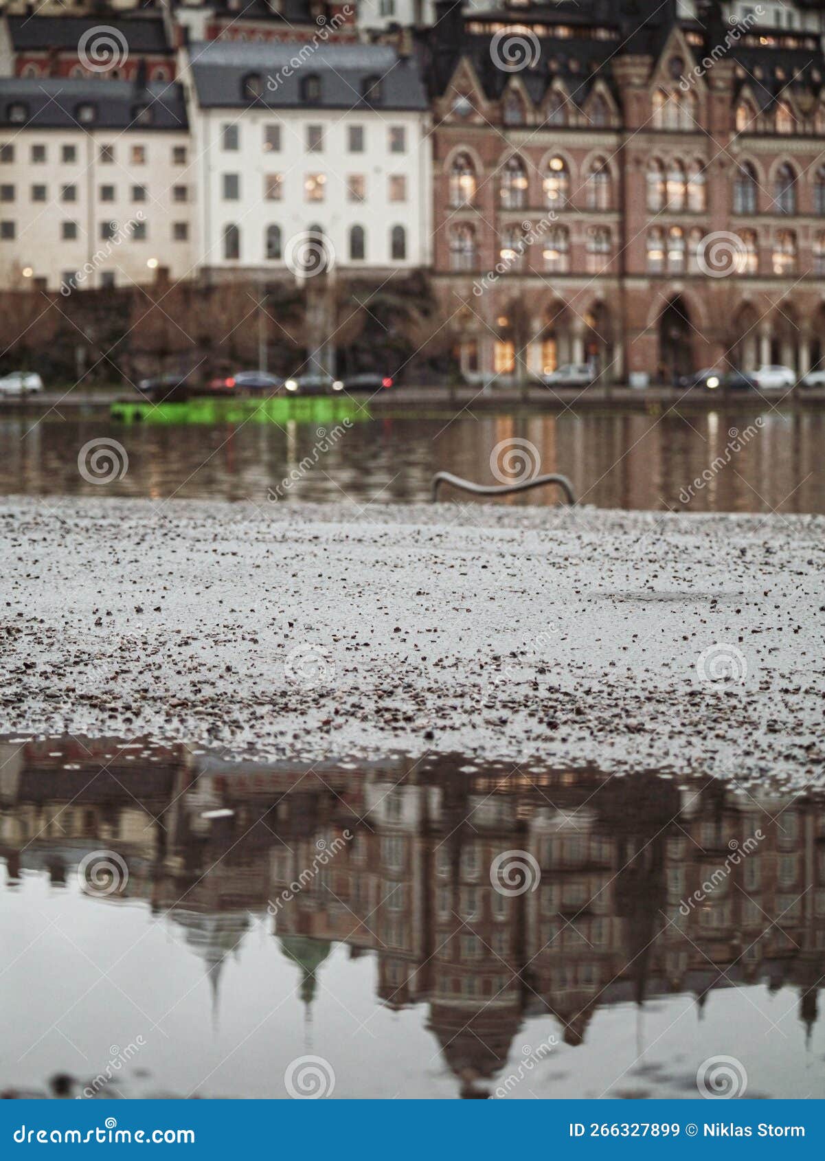 Reflection of Buildings in a Puddle Next To River Stock Image - Image ...