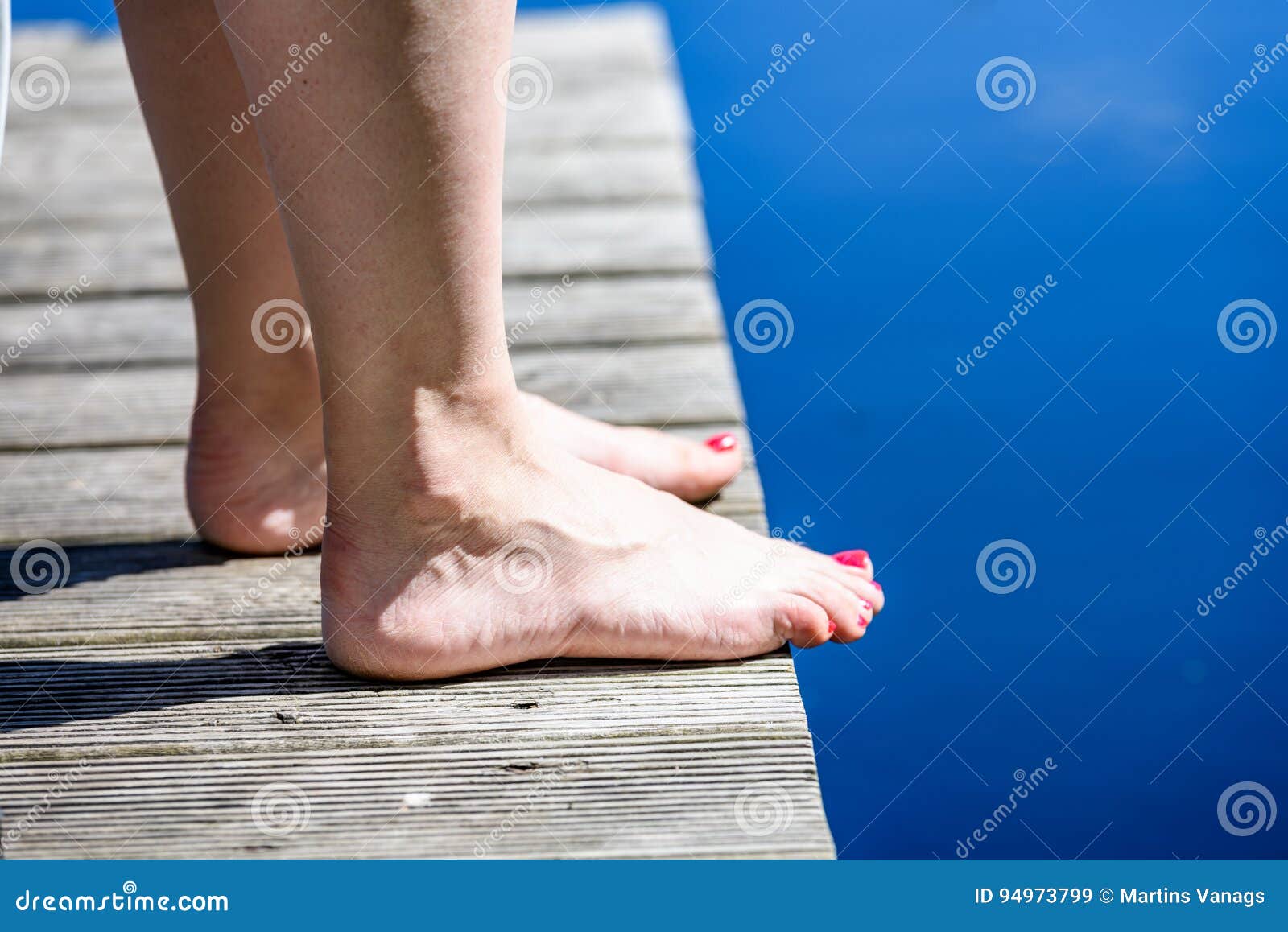 Reflection of Clouds in the Lake with Boardwalk and Womans Legs Stock ...