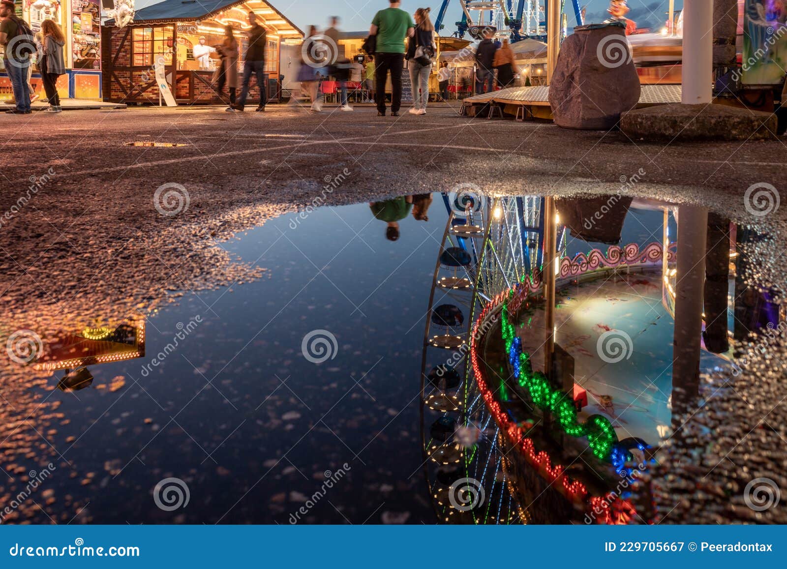 Reflection of Colourful Illuminated Motion of Carousel and Ferris Wheel ...