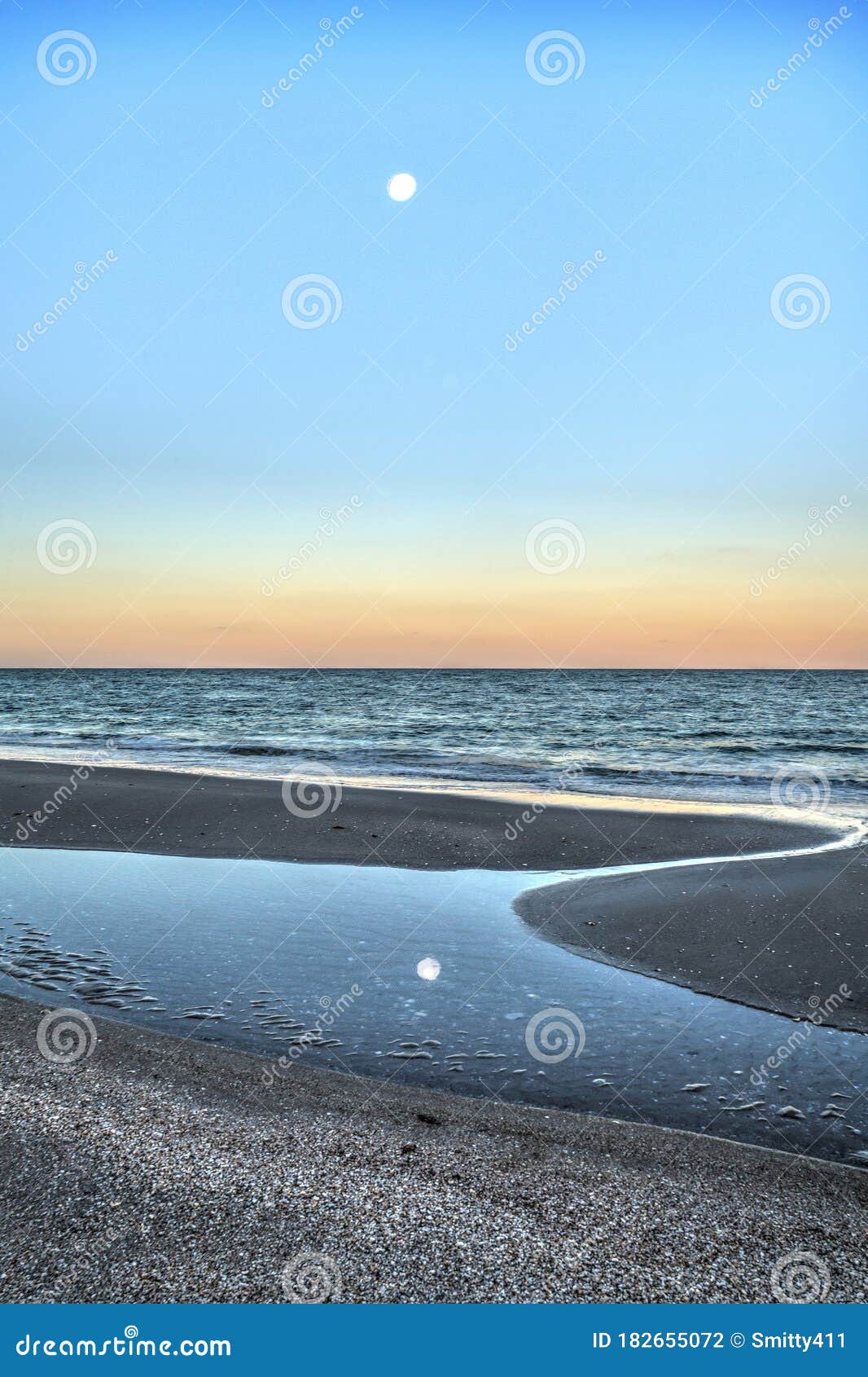 Reflection of the Full Moonset in a Tidal Pool in Front of the Ocean ...