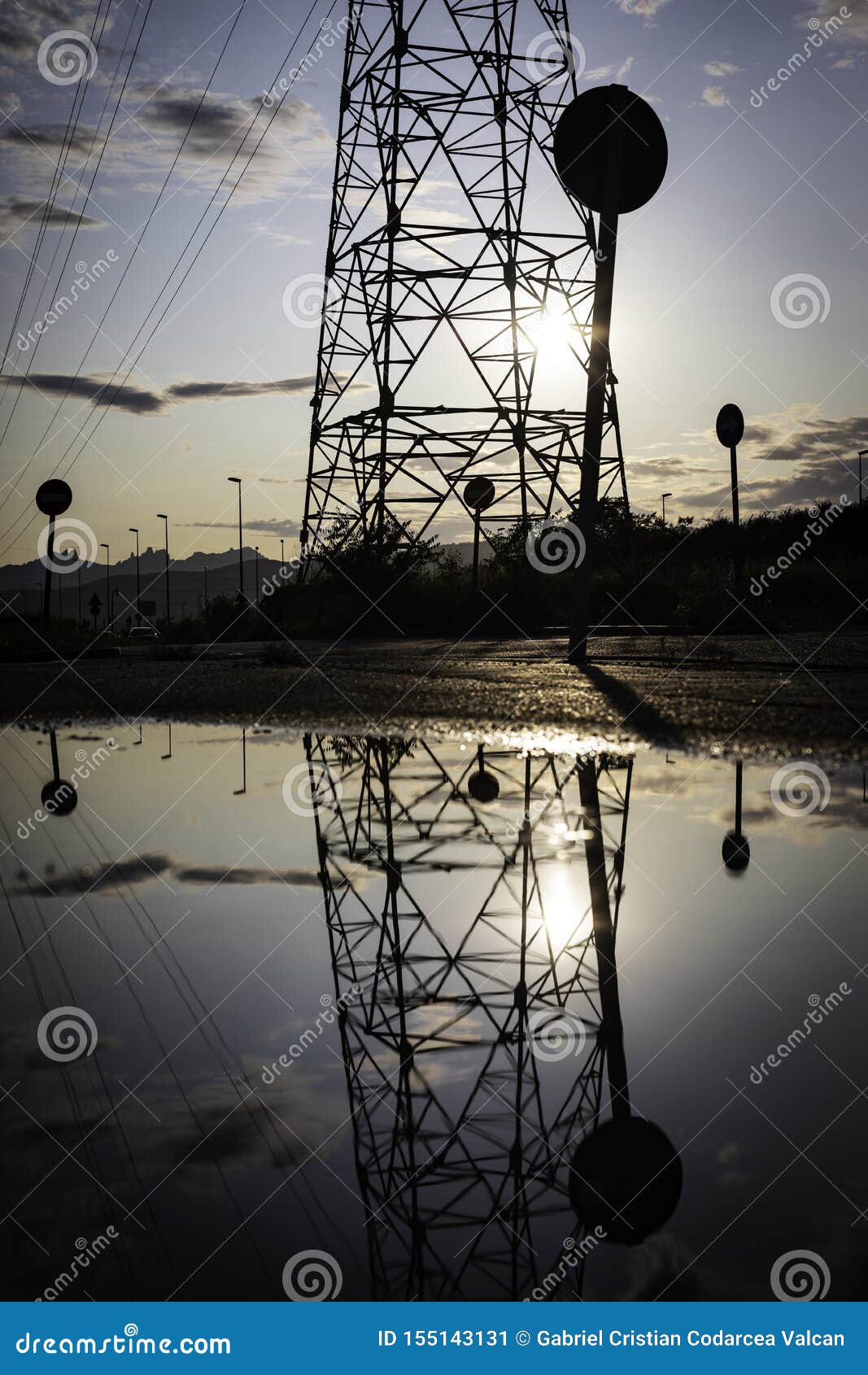 Reflection Of A High Voltage Tower In A Pond With The Sky Hidden Behind ...