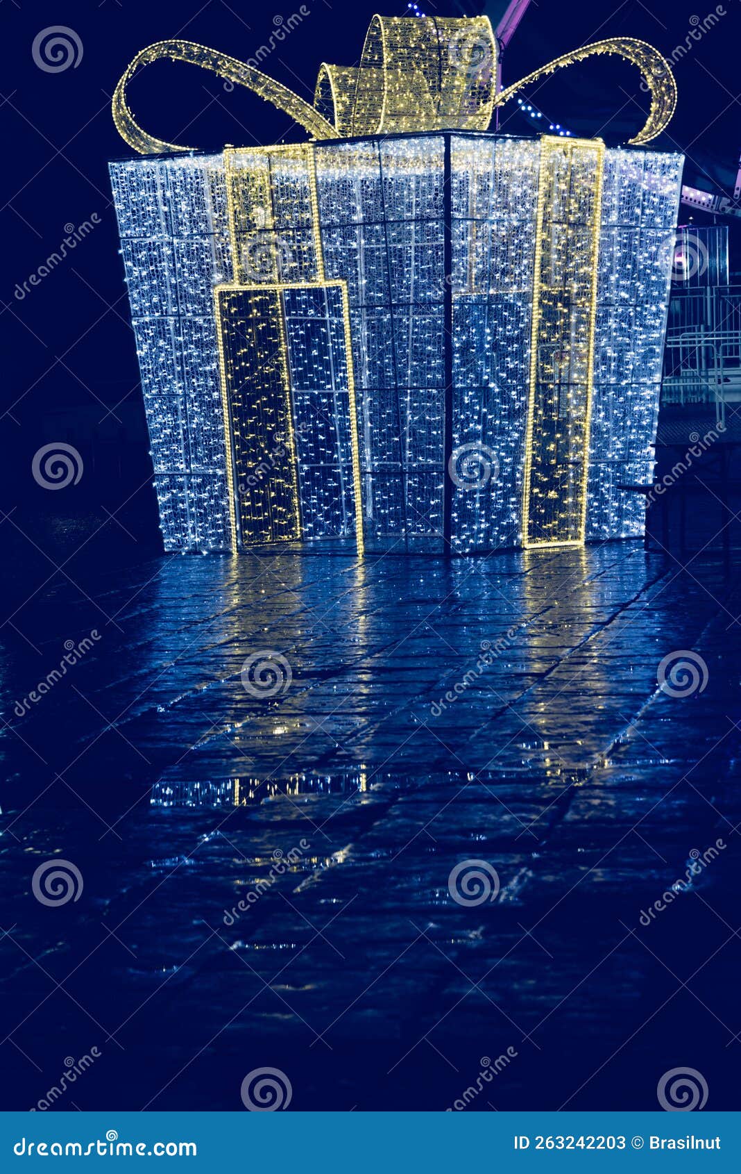 Reflection of Illuminated Giant Present Shape on Wet Surface Stock ...