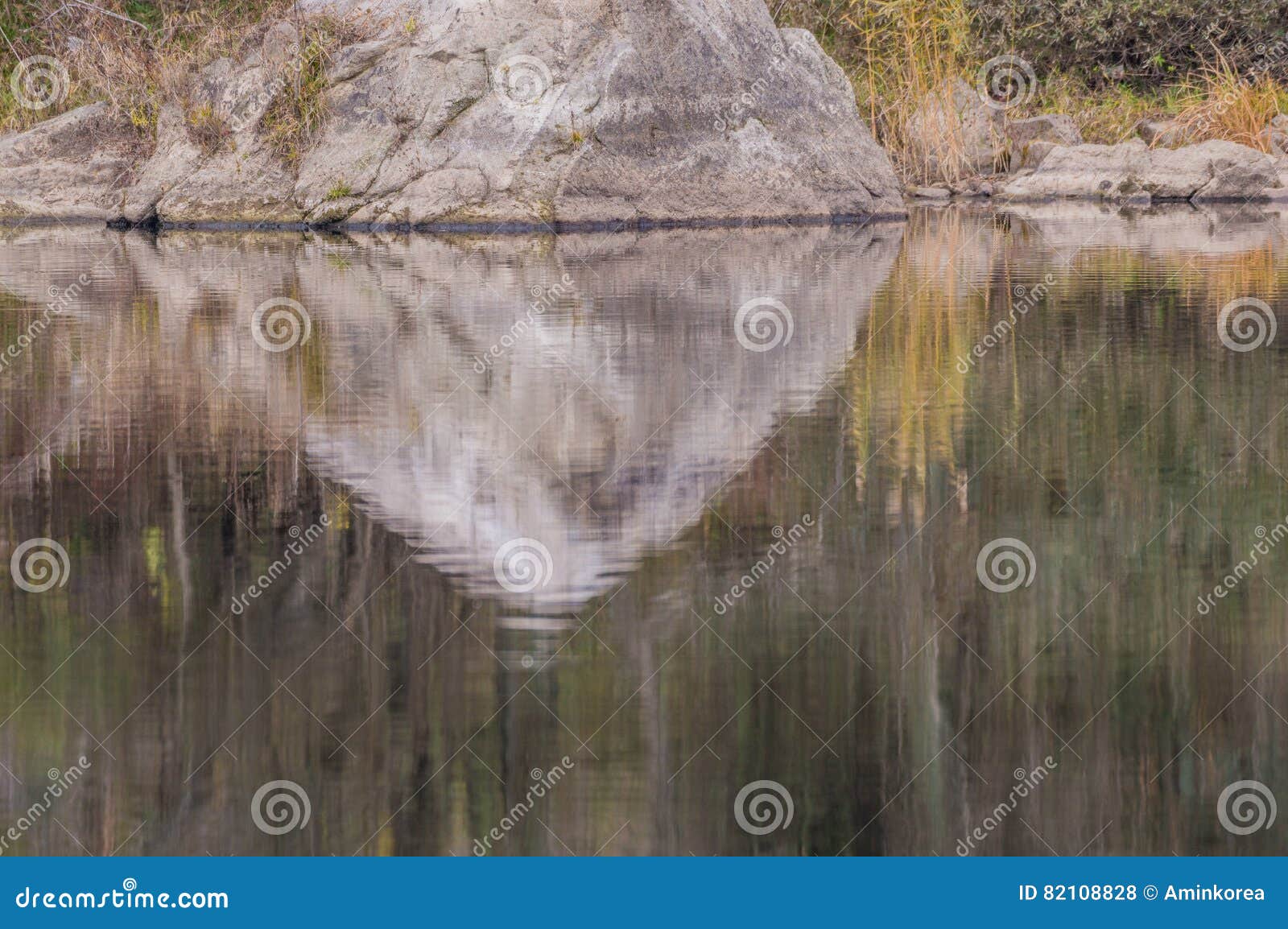 Reflection of Large Boulder in the Shape of a Triangle Stock Photo ...