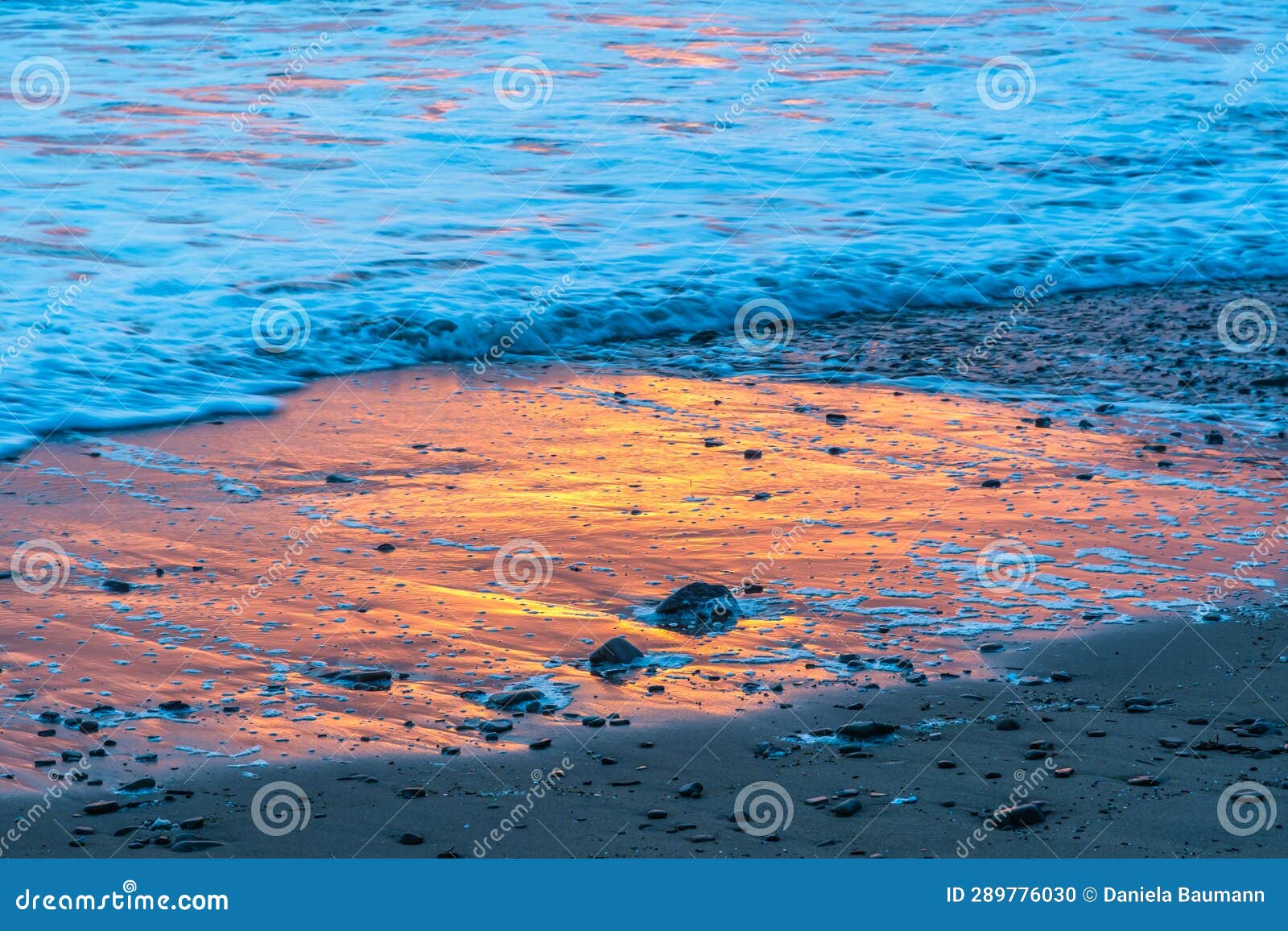 Reflection of the Light of the Setting Sun in the Water on the Beach ...