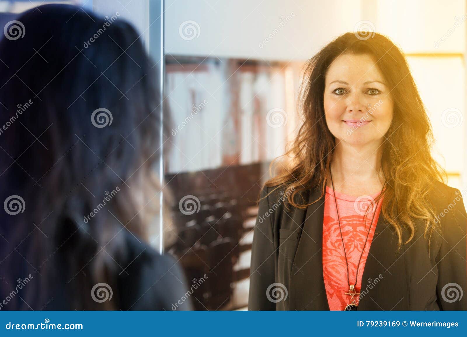 Reflection in Mirror of Brunette Woman Smiling at Camera Stock Image ...