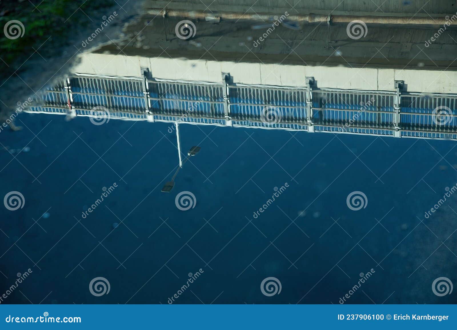Bridge reflection in water stock photo. Image of puddle - 237906100