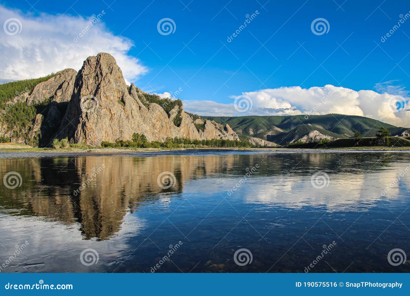 A Reflection of a Mongolian Mountain in the Evening Sun on a River ...