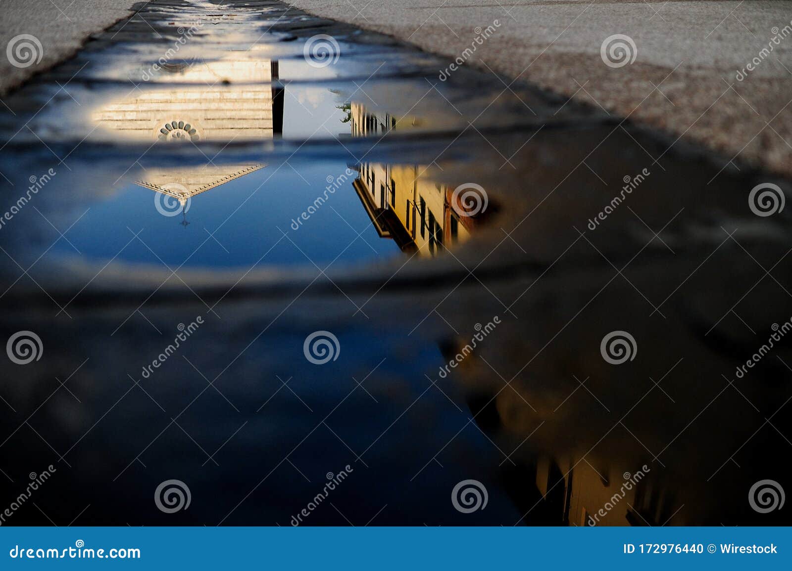 Reflection of the Old Buildings and the Sky on the Rainwater on the ...