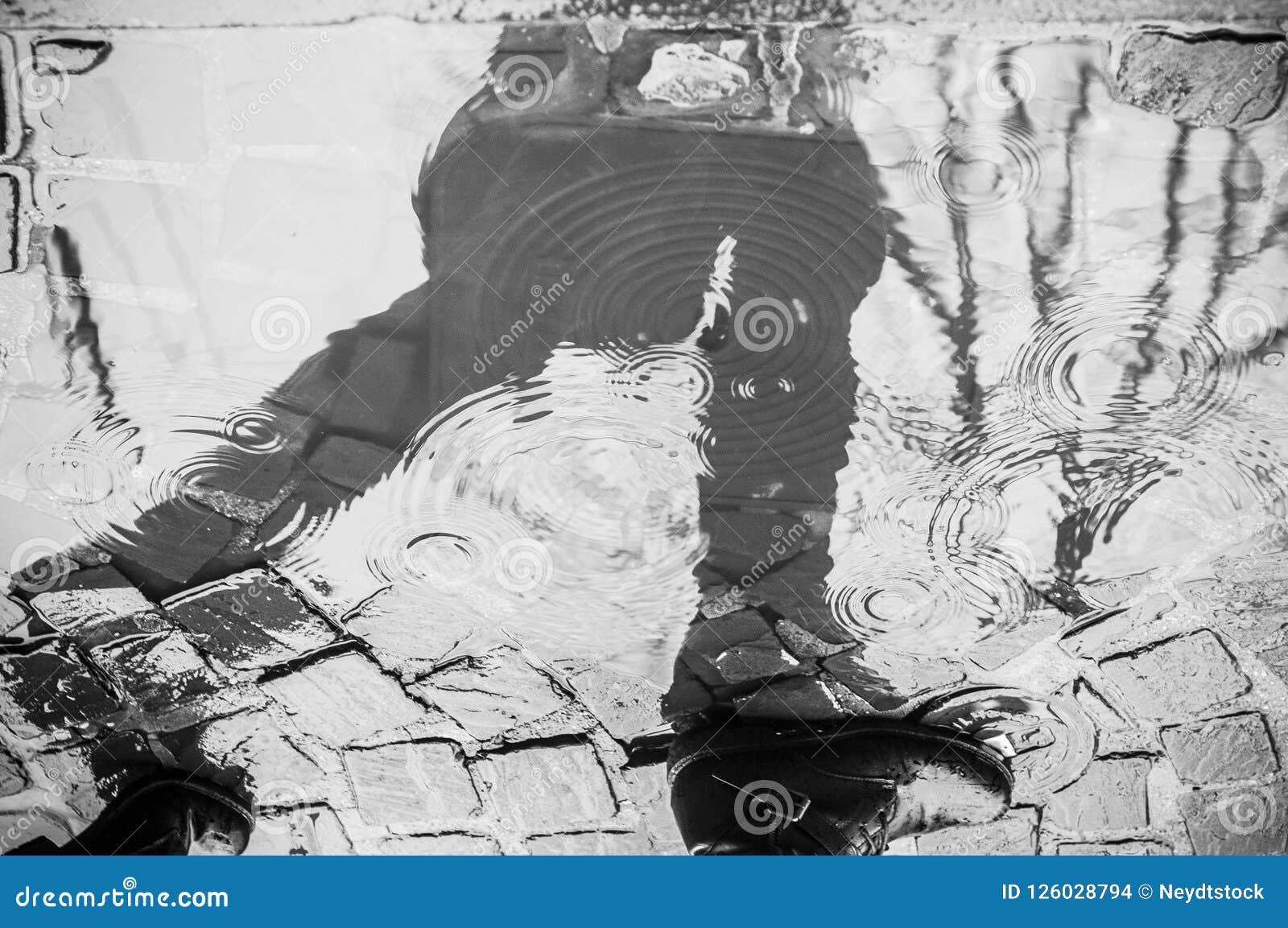 Reflection of a Person Walking in a Puddle in the Rai Stock Photo ...