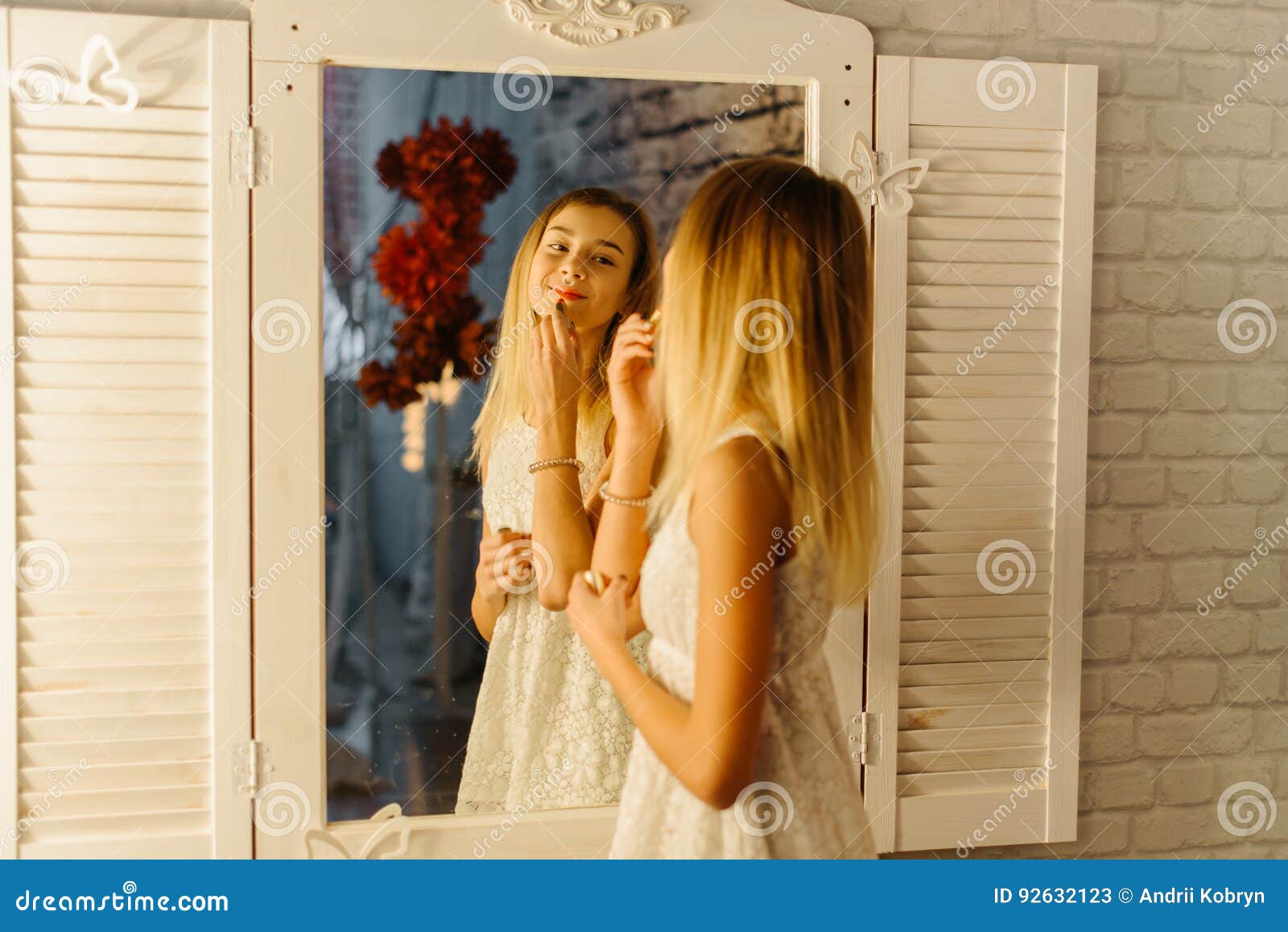 The Reflection of the Pretty Smiling Girl Applying the Lips in the ...