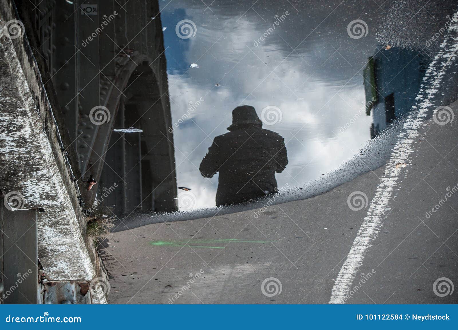 Reflection in a Puddle of a Man Walking in the Street Stock Photo ...
