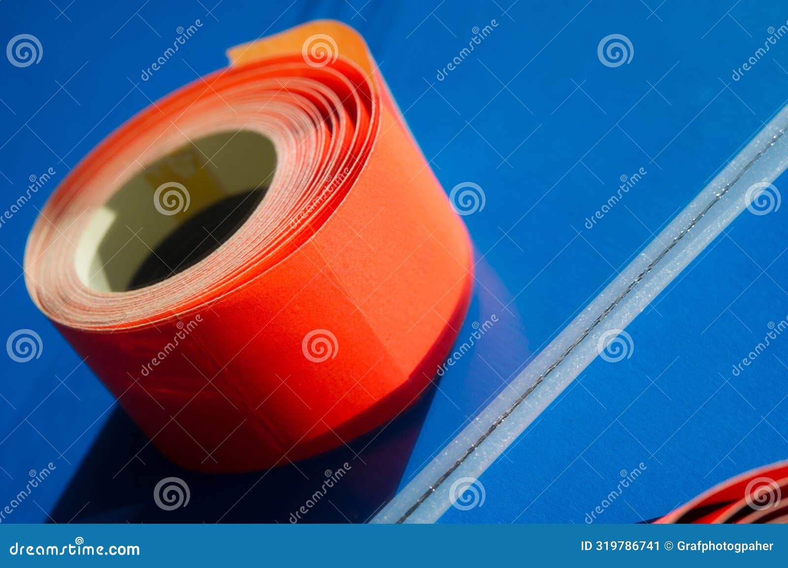 Reflection of the Red Roll of Stickers on a Blue Background Stock Image ...