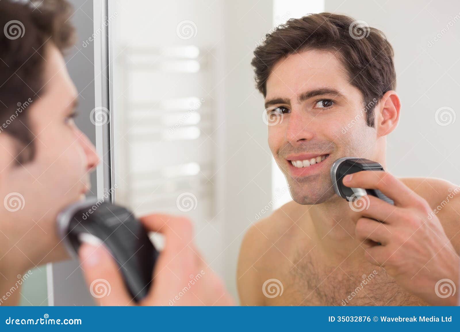 Reflection of Shirtless Man Shaving with Electric Razor Stock Photo ...