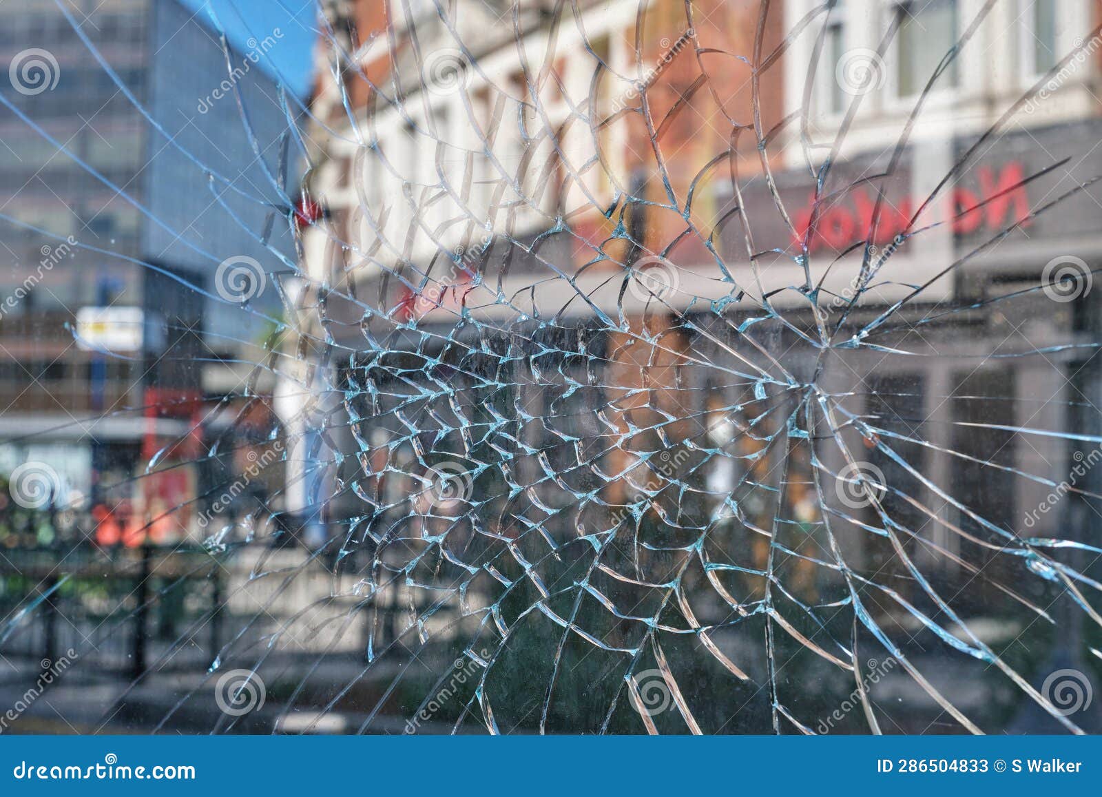 Reflection in Smashed Glass of Town Centre Window. Stock Image - Image ...