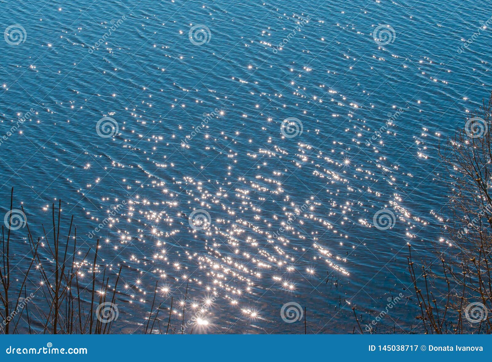 Reflection of the Sun on the Water Surface. Blue Background. Stock ...