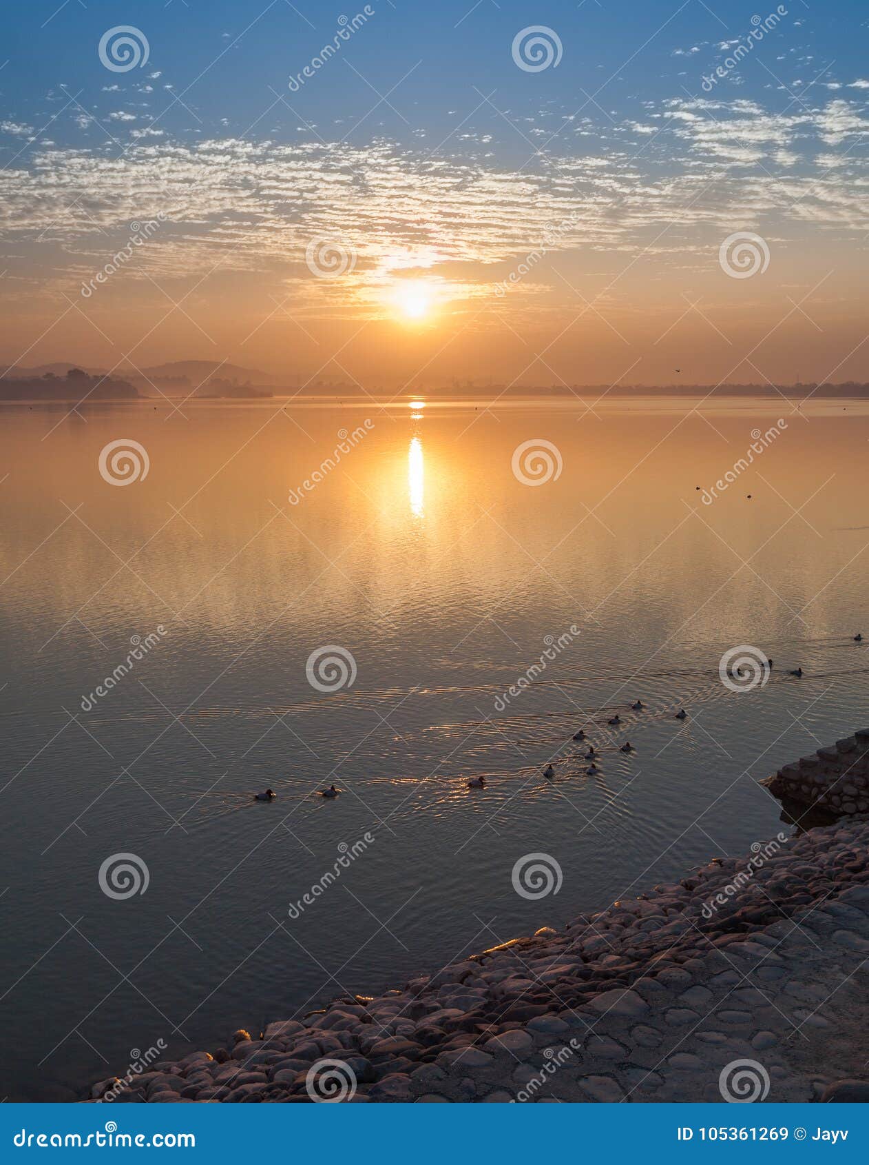 Sunset at Distant Edge of Lake Stock Image - Image of lake, covered ...
