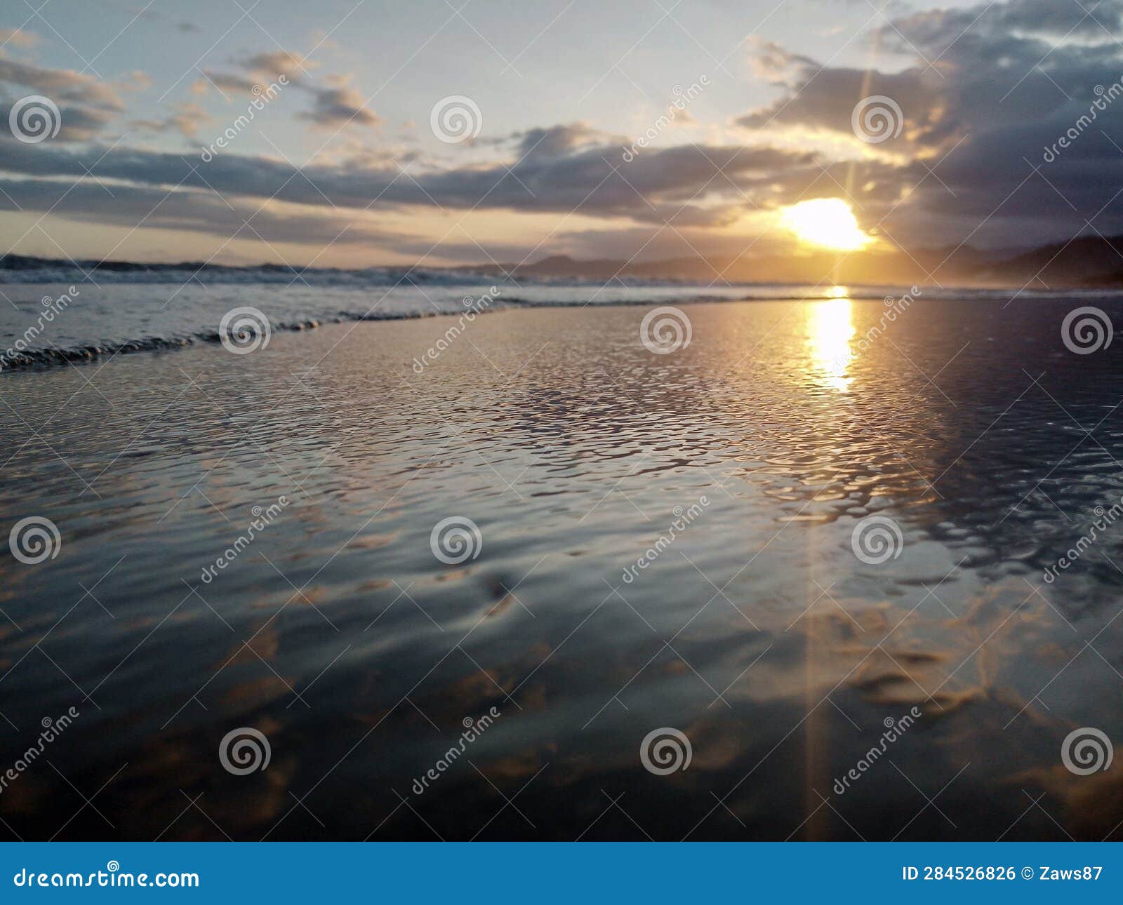 The Reflection of the Sunset on the Beautiful Sand Beach Stock Photo ...