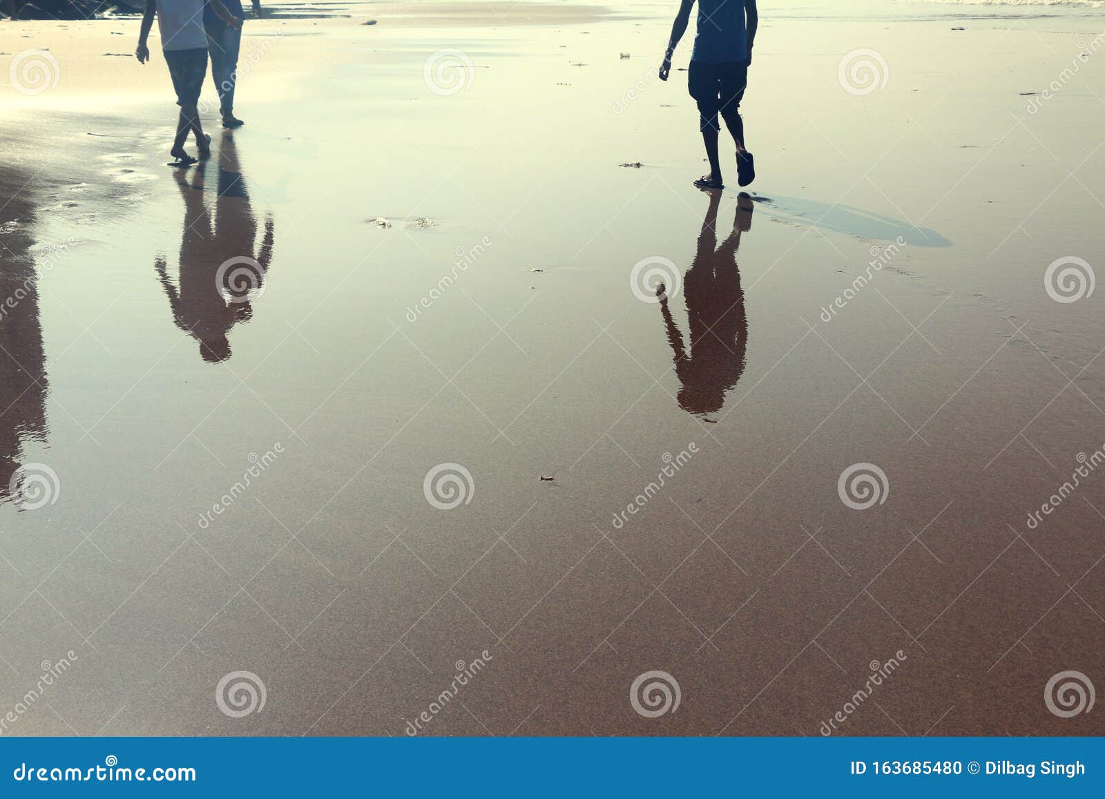 Reflection of Two Human Walking on the Beach Stock Photo - Image of ...