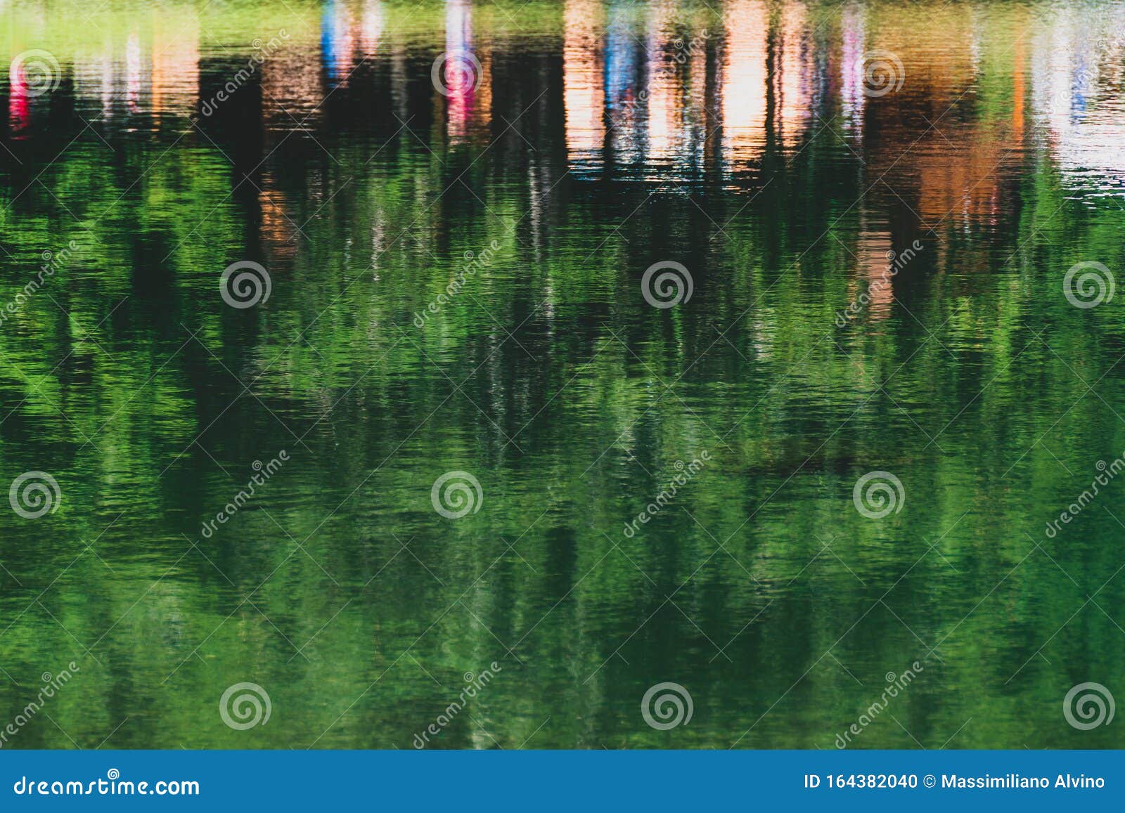 Reflection on the Water of People on the Edge of a Mountain Lake Stock ...
