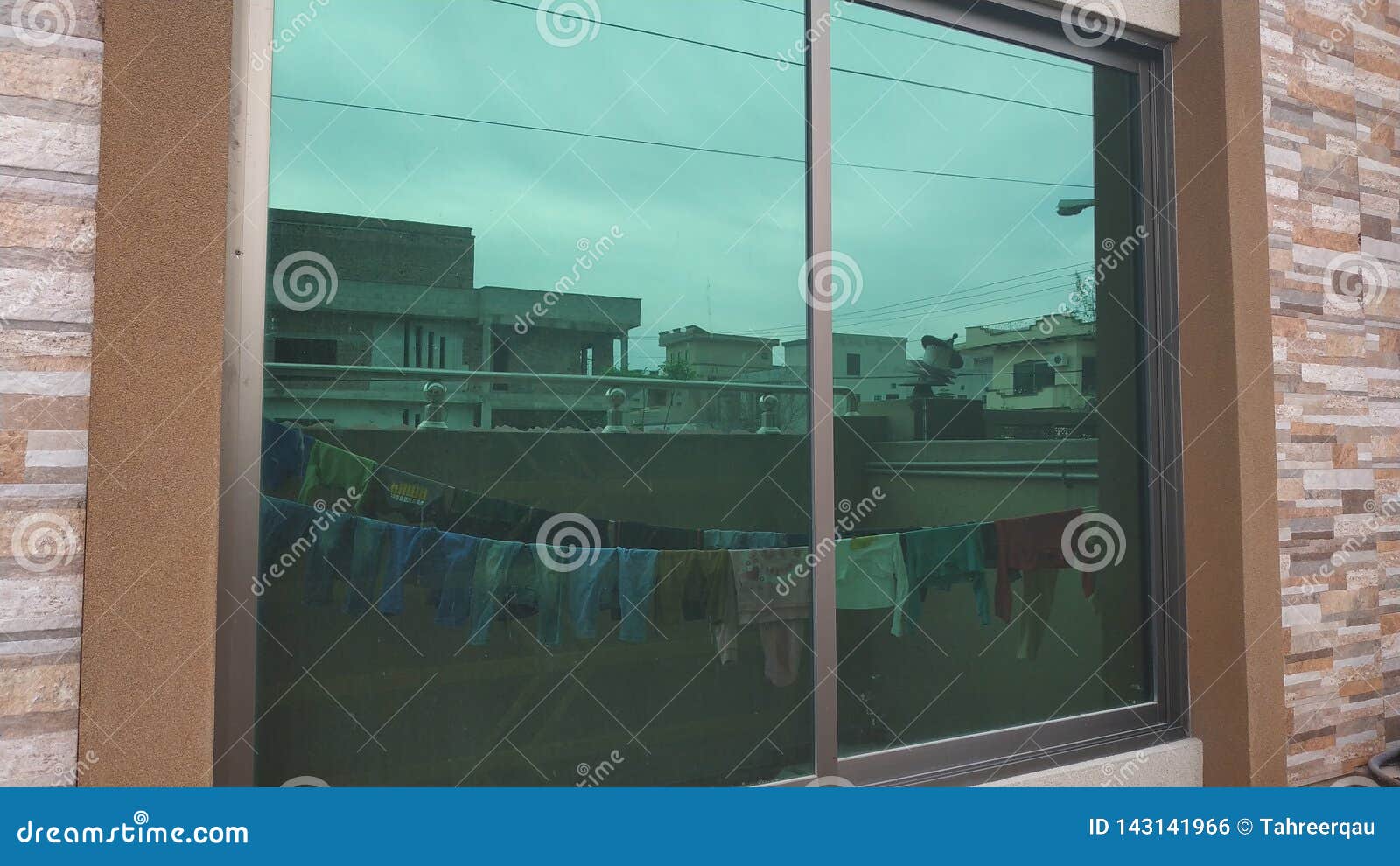 Reflection on Window of a House Stock Photo - Image of cloth, clothes ...