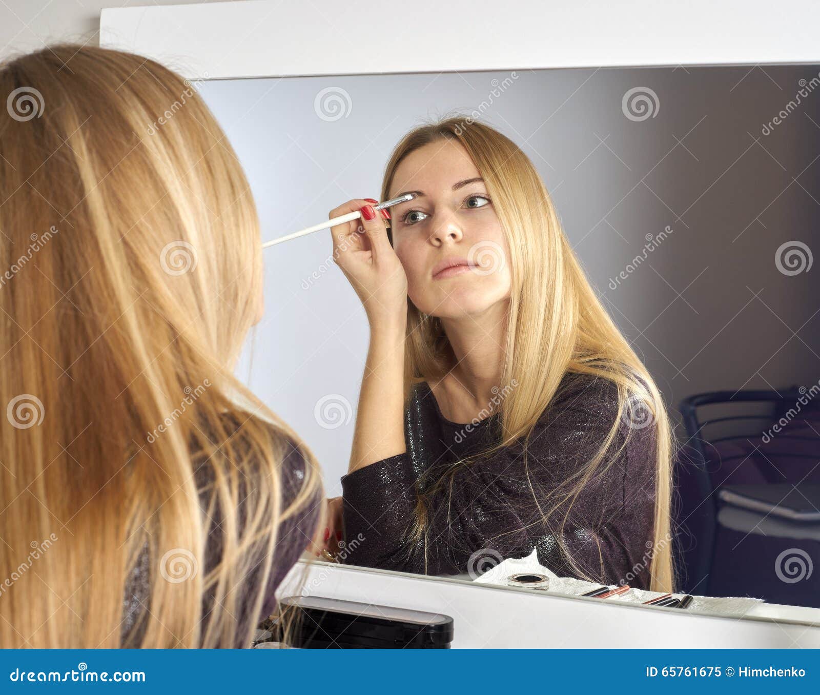 Reflection of Young Beautiful Woman Applying Her Make-up, Looking in a ...