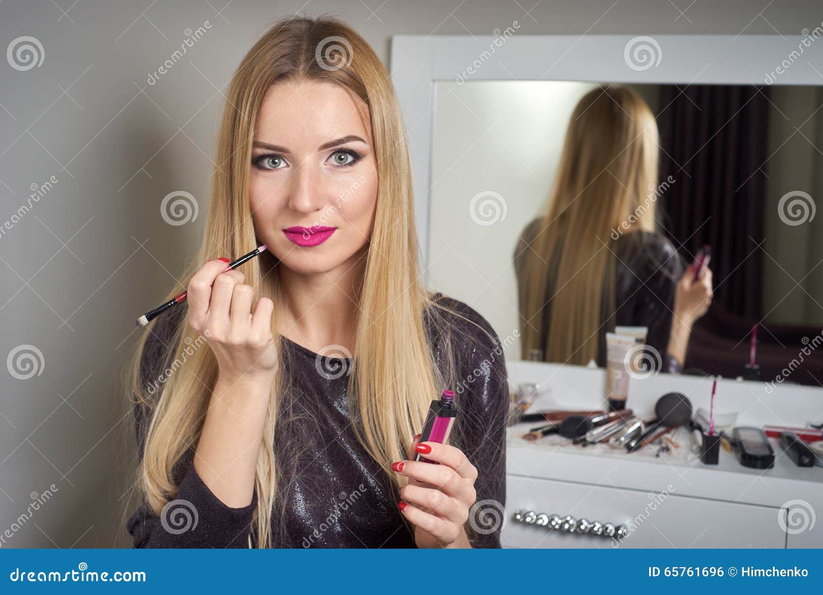 Reflection of Young Beautiful Woman Applying Her Make-up, Looking in a ...