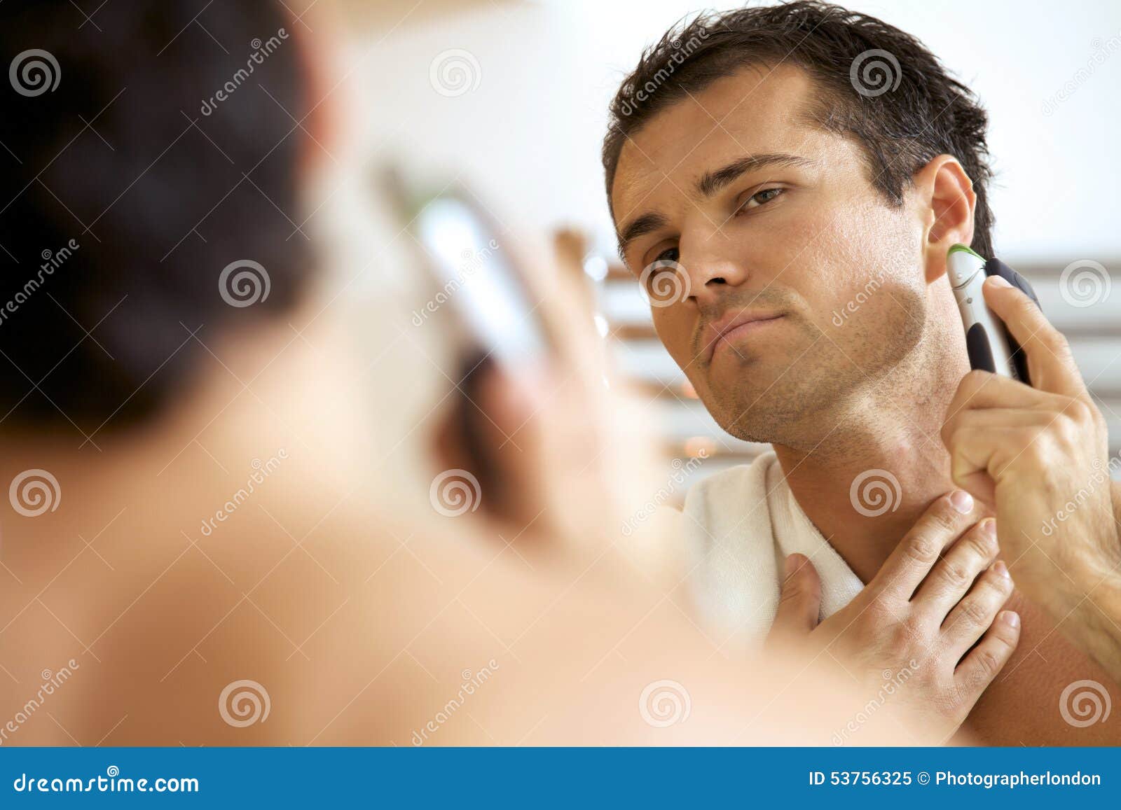 Reflection of Young Man in Mirror Shaving with Electric Shaver Stock ...