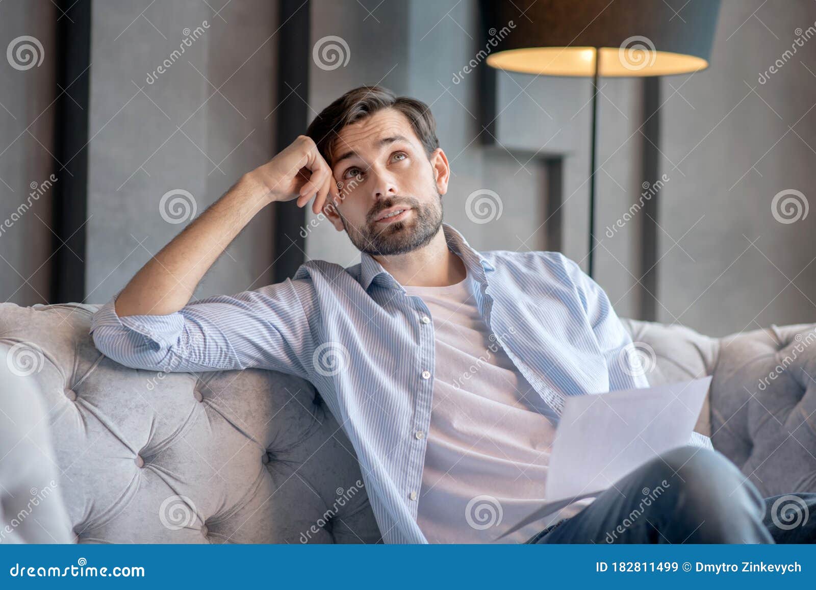 Thinking Sad Man Sitting with a Document in His Hand. Stock Image ...