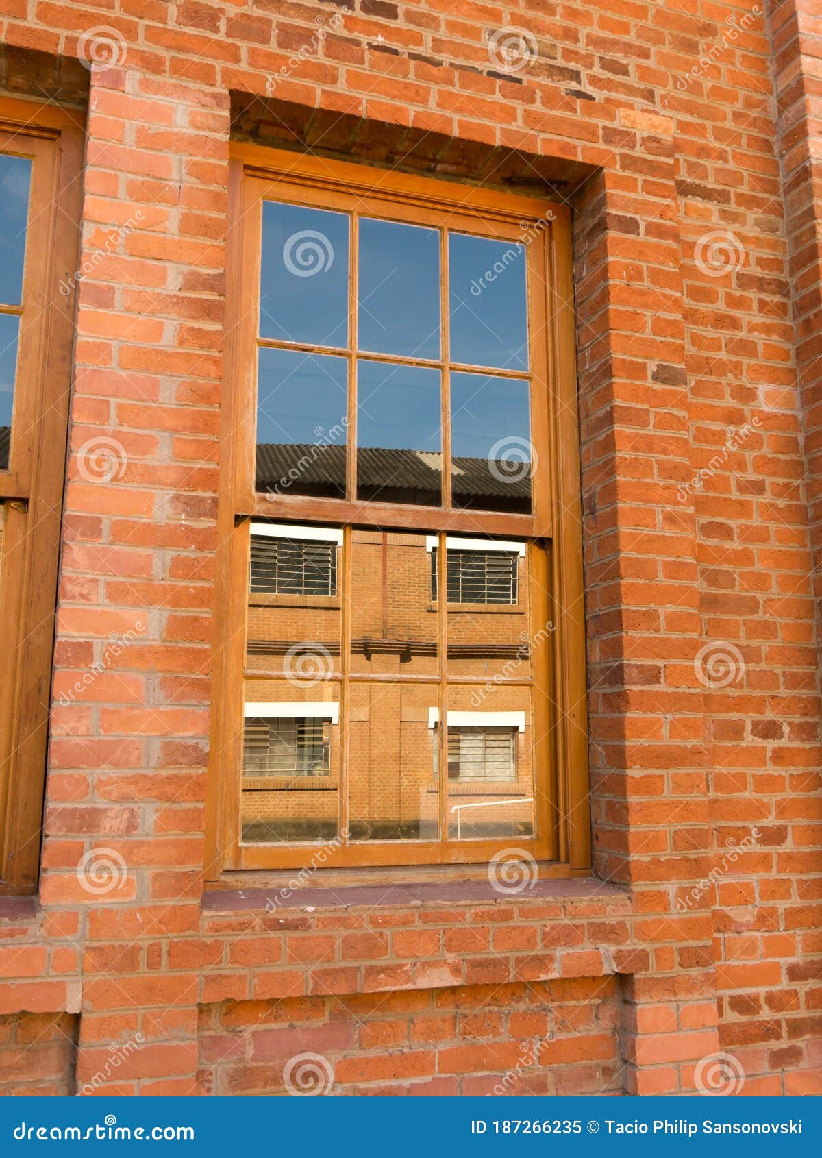 Reflections on Glass Windows in Brick Wall Stock Image - Image of clay ...